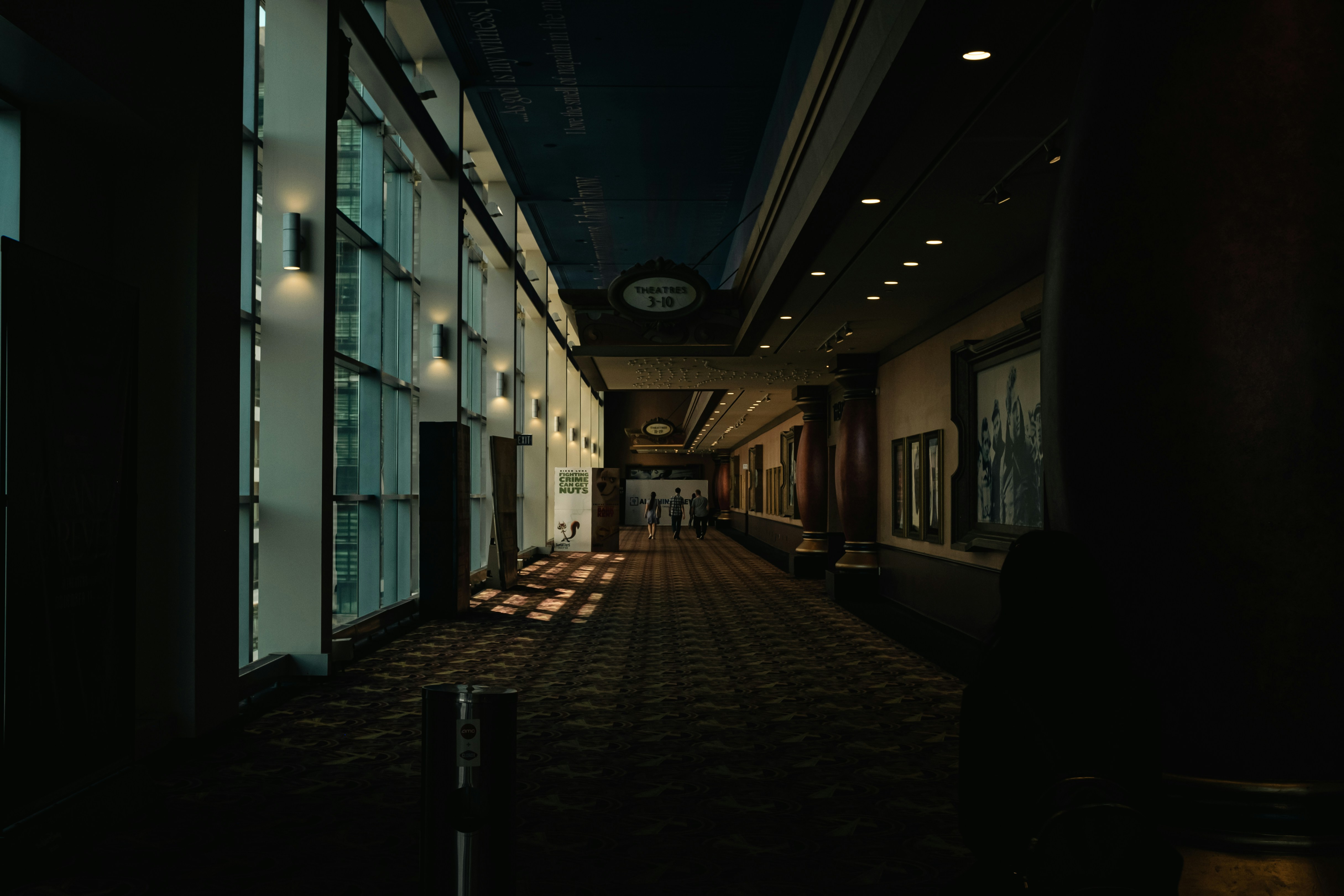 A dimly lit hallway with a clock on the wall photo – Free Boston Image ...