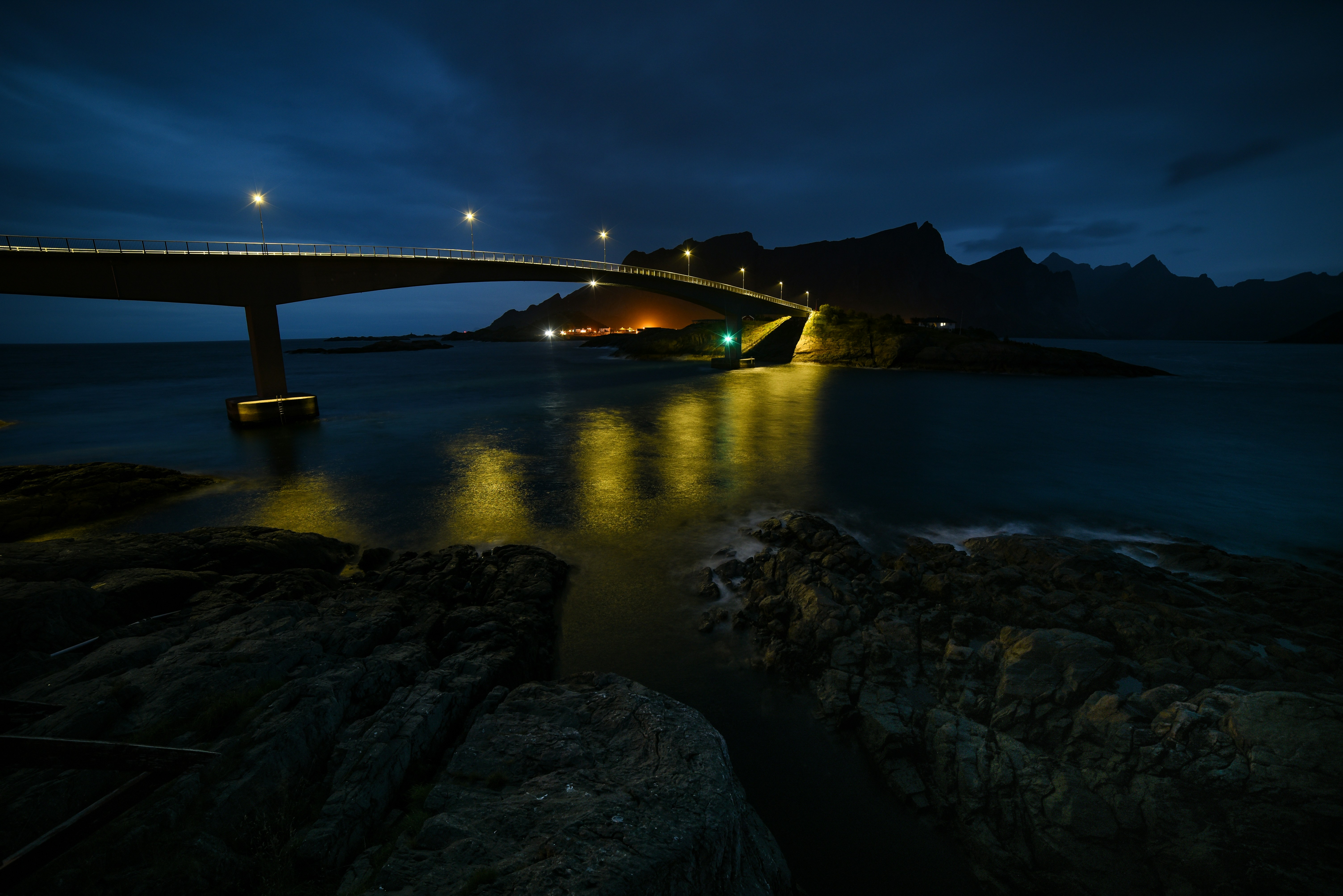 a bridge over a body of water at night