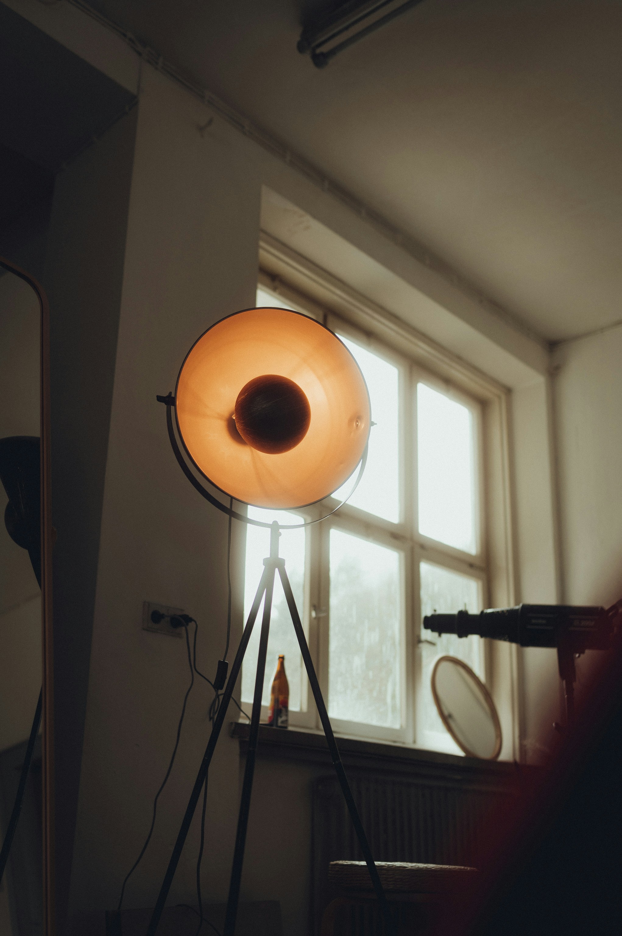 Amber Halo on a Tripod: Quiet Studio Light by the Window