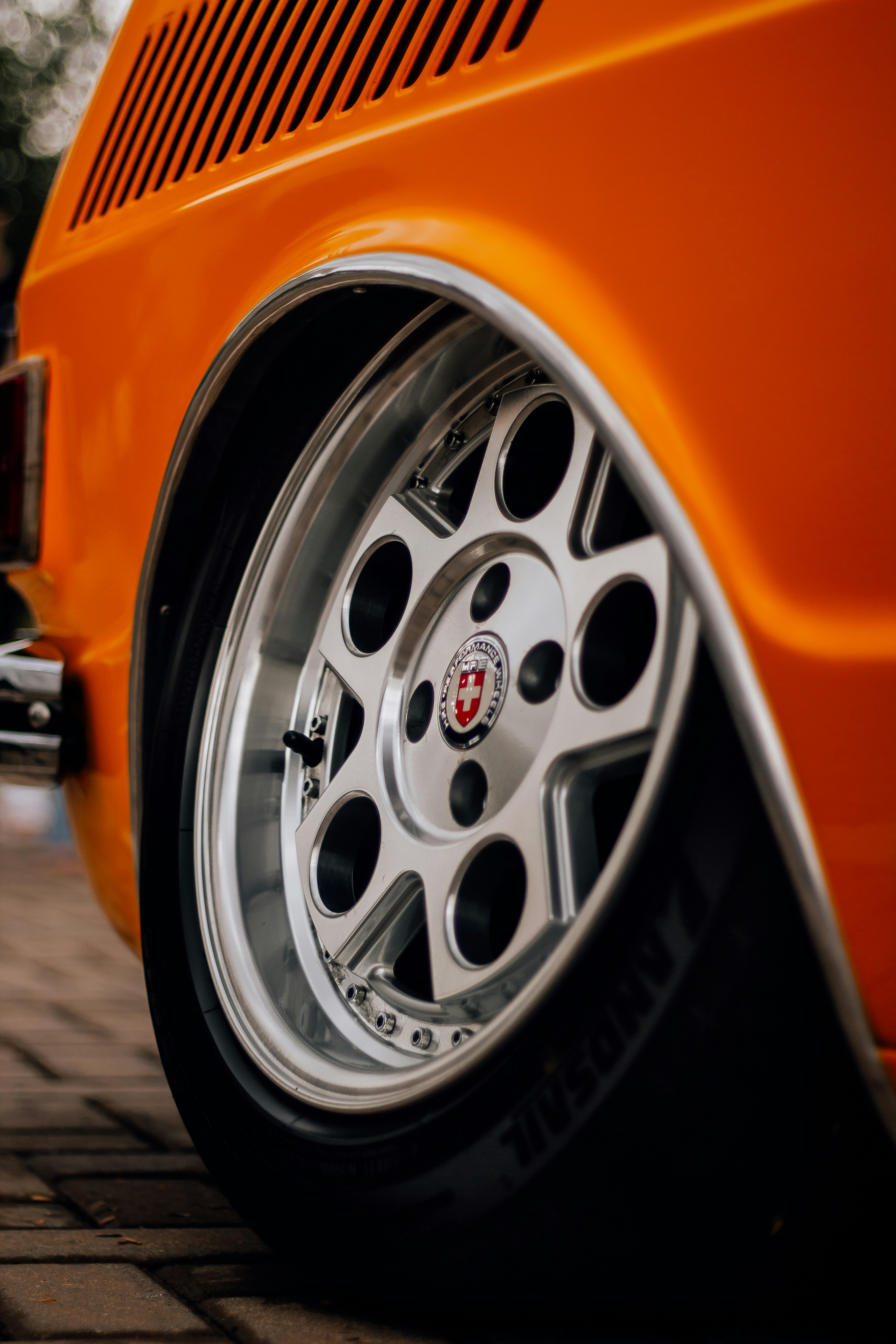 a close up of a car tire on a brick road