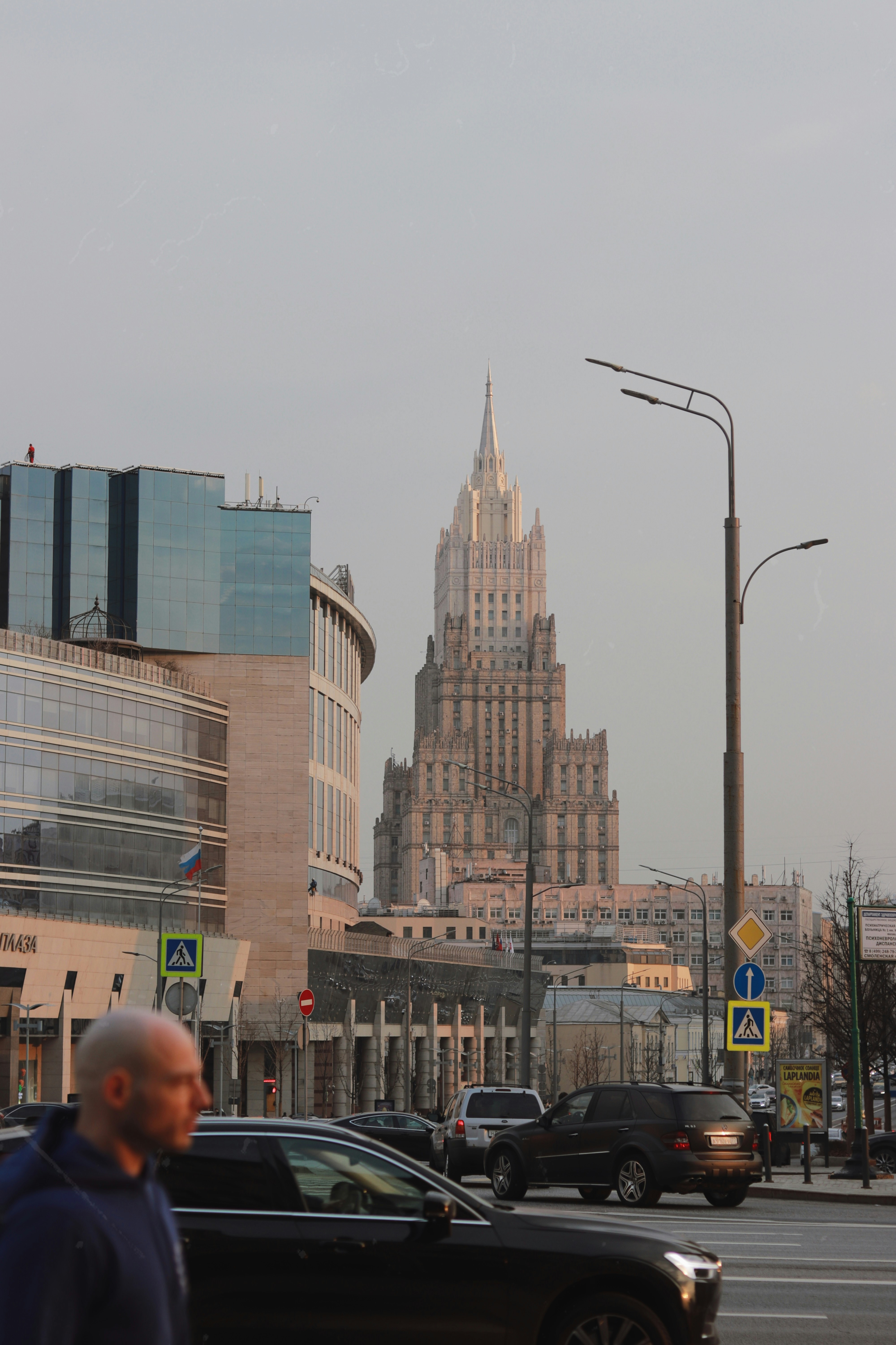 Urban Needle Meets Glassfront: A Street-Level Convergence Under a Distant Spire