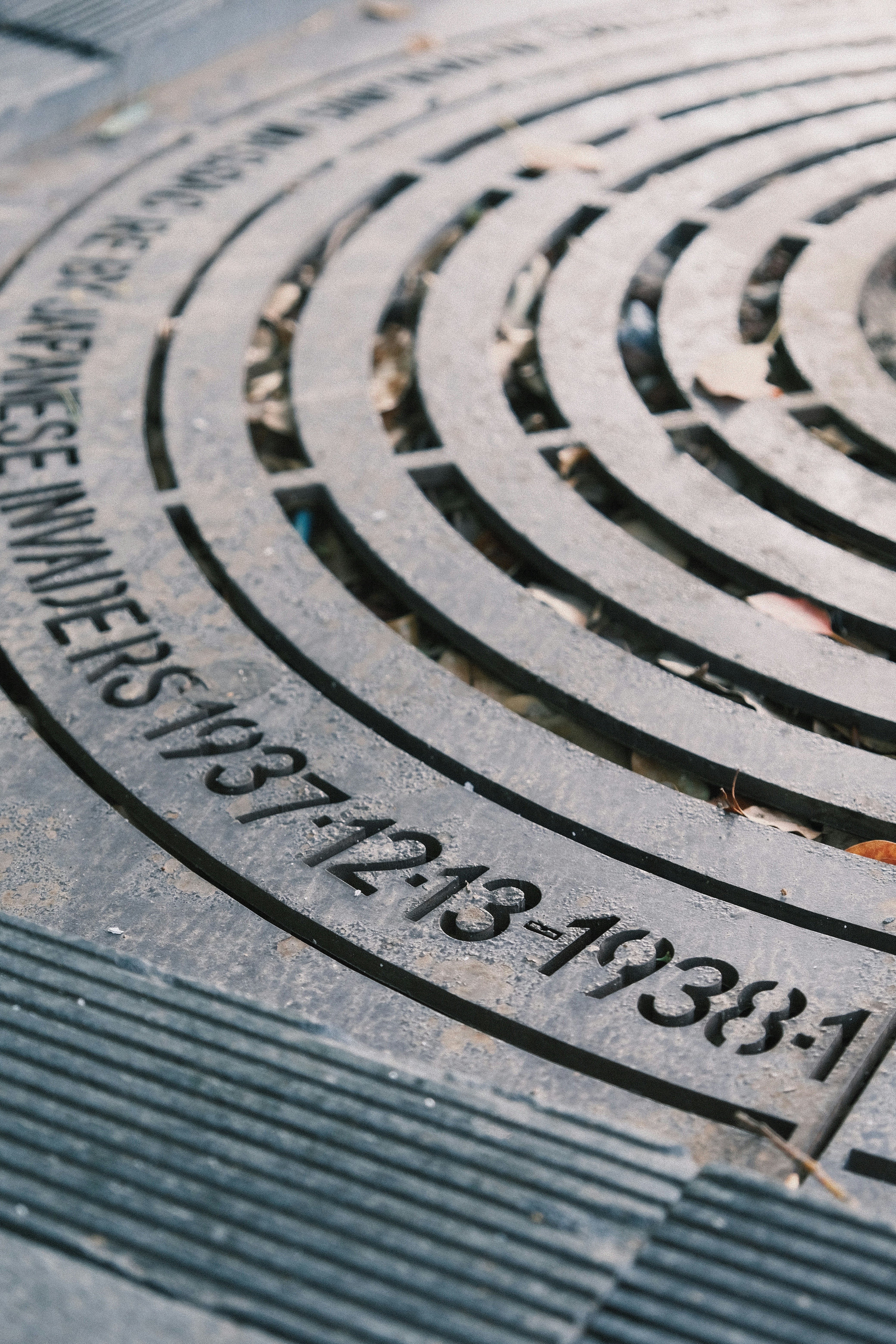 A manhole cover with the names of different cities photo – Free Image ...