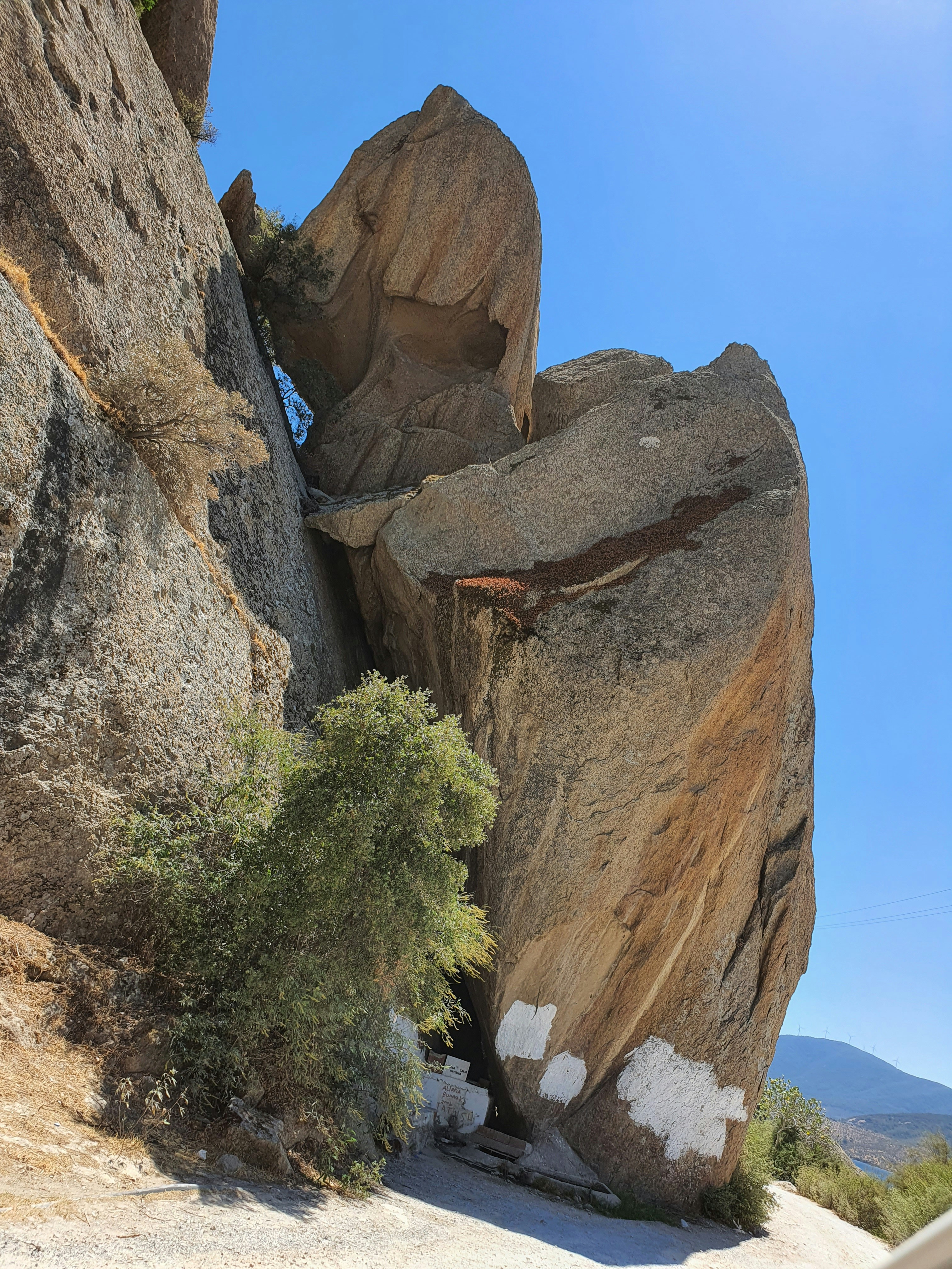 Craggy Spires Guard a Sunlit Path Under a Pristine Blue Sky