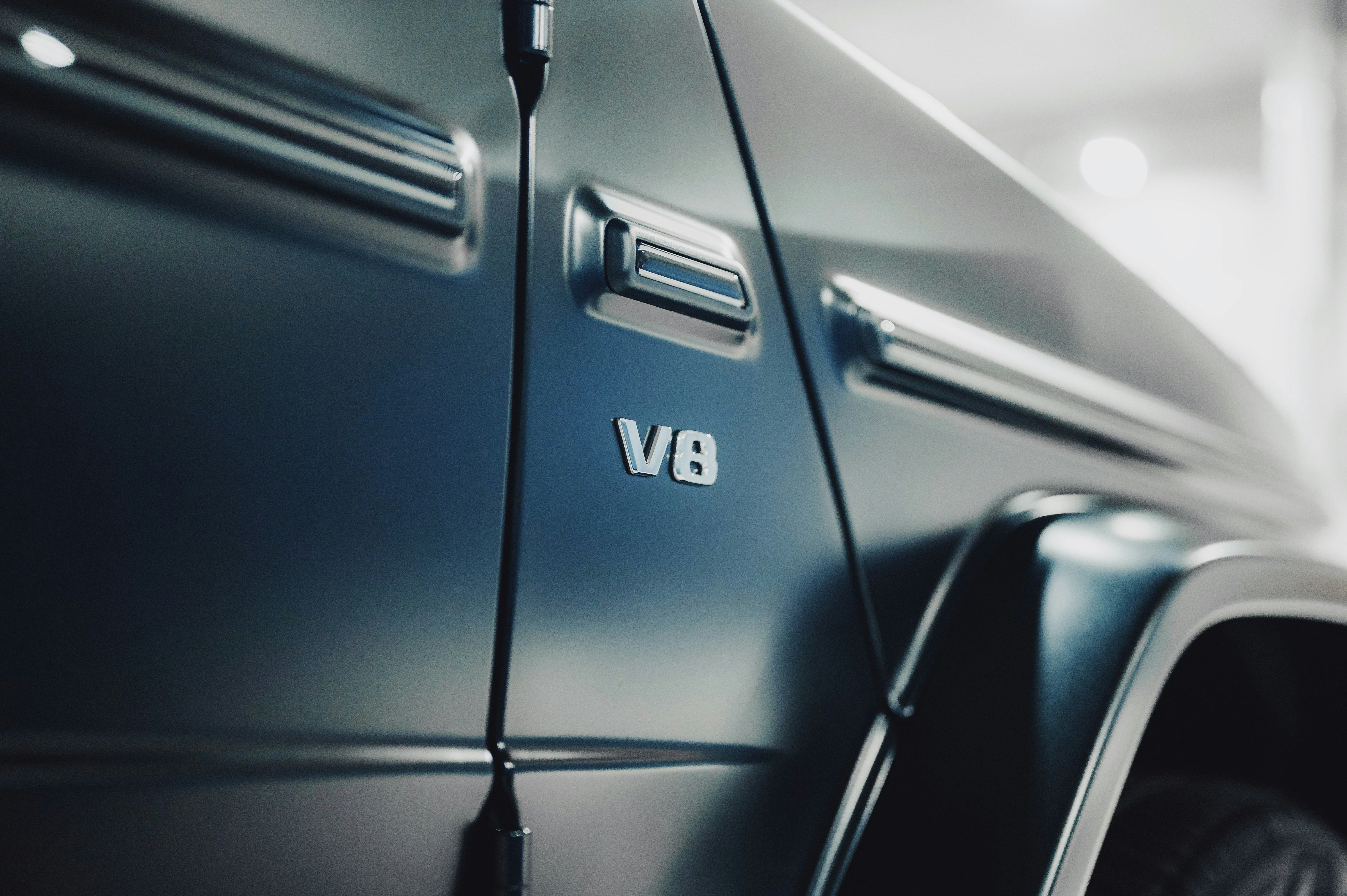 V8 Emblem on Painted Steel: A Tight Portrait of Power