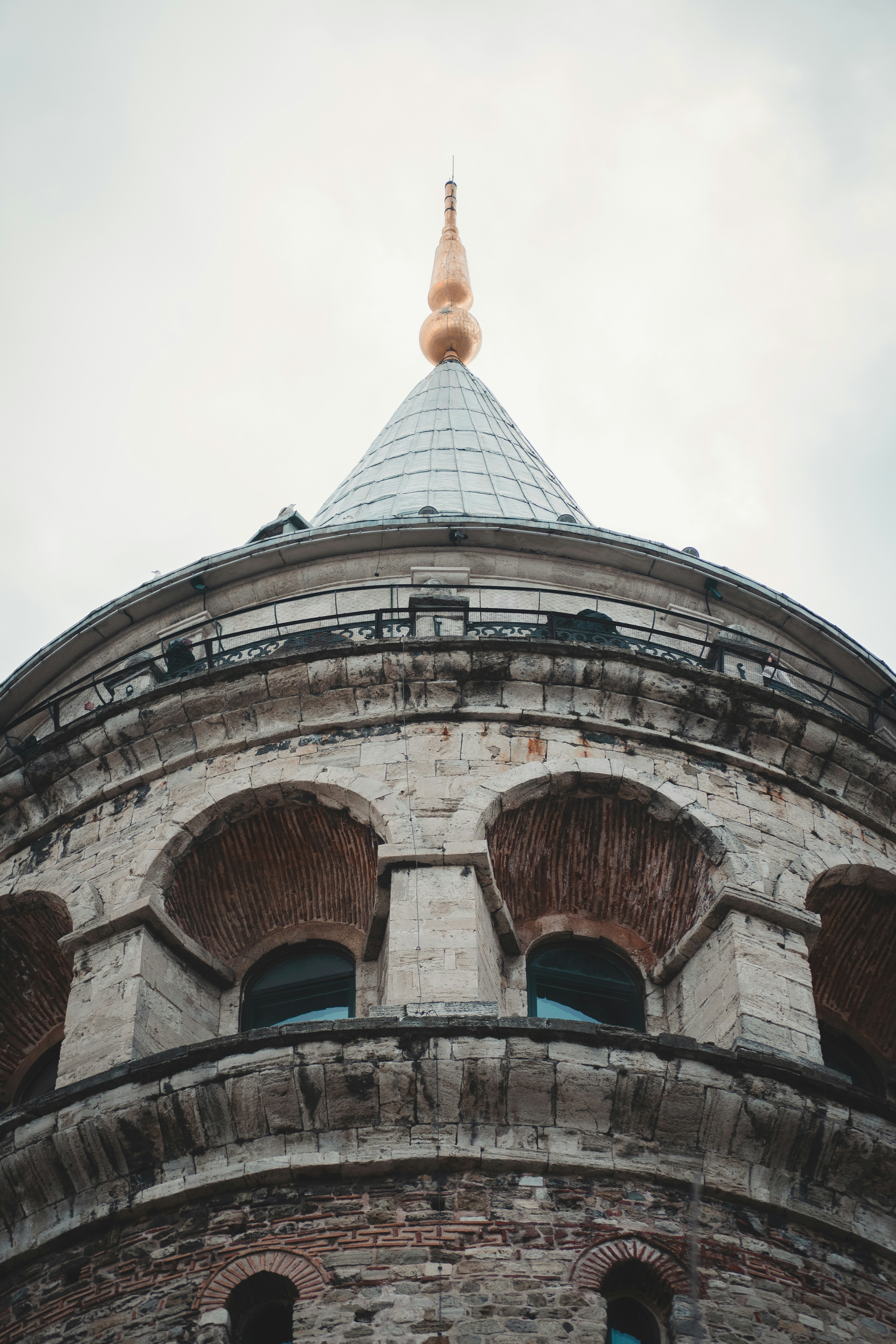 A tall brick building with a pointed roof photo – Free Galata Image on ...