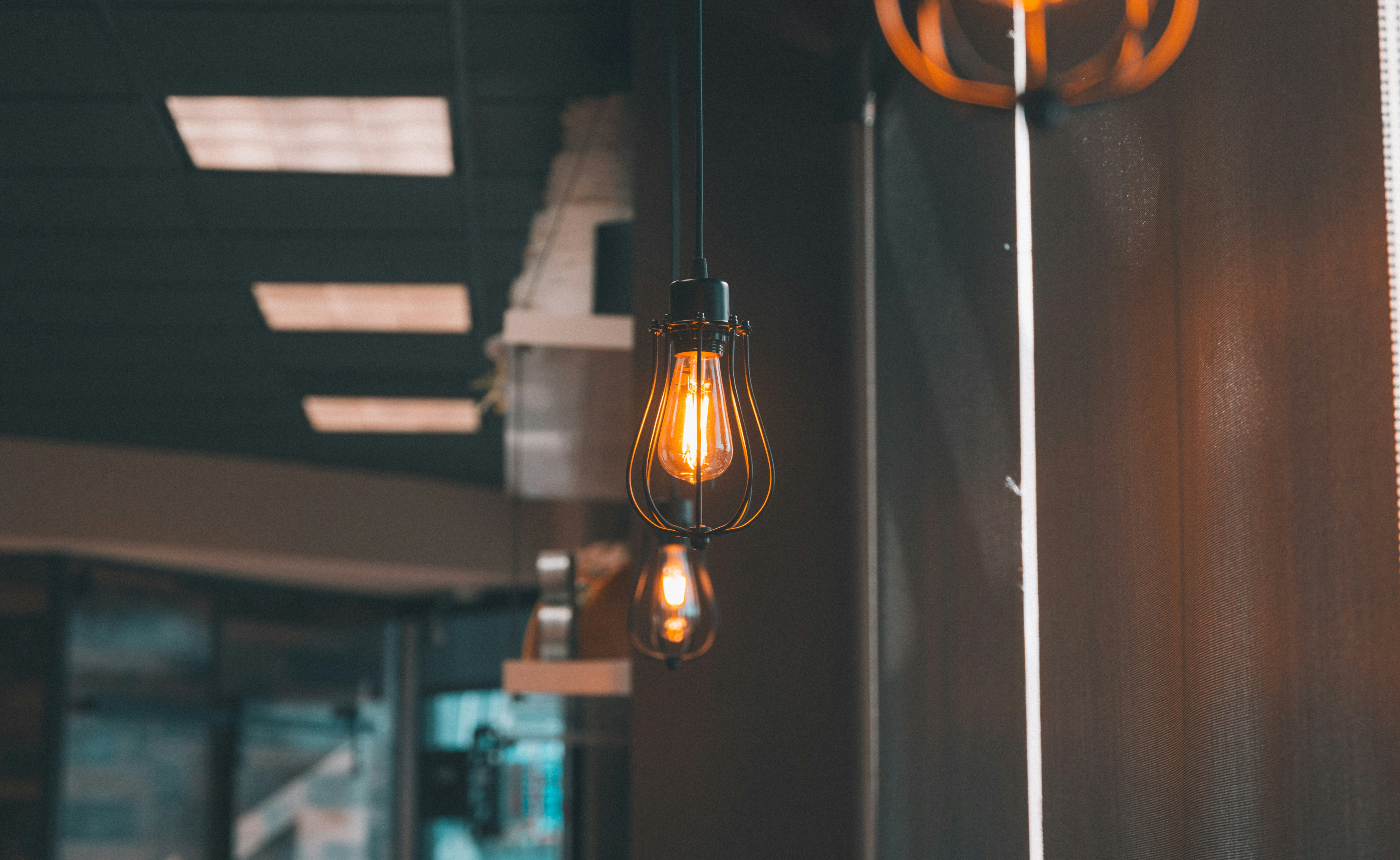 A couple of light bulbs hanging from a ceiling photo – Free Blue Image ...
