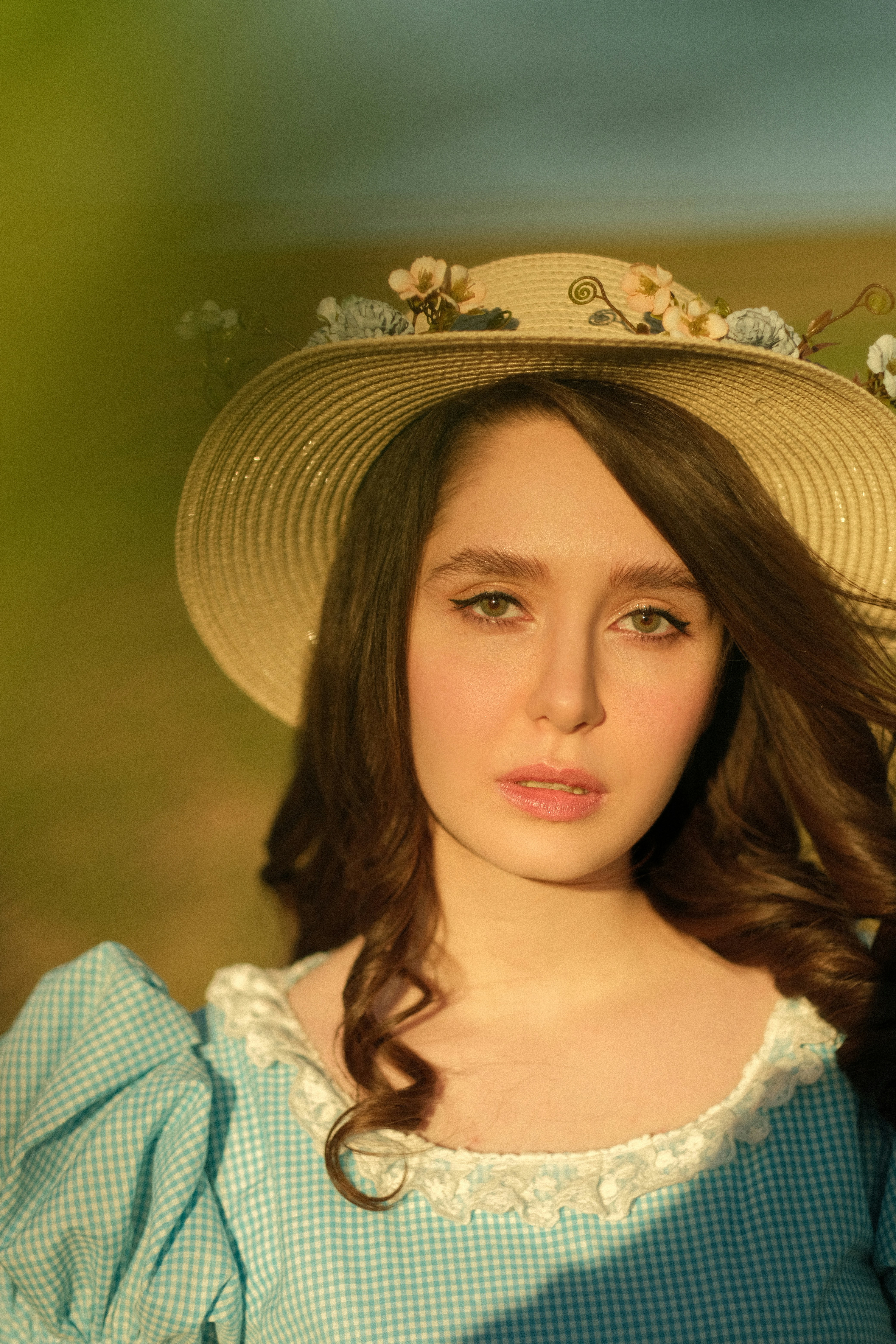 Sunlit Grace: Portrait of a Woman in a Floral Straw Hat
