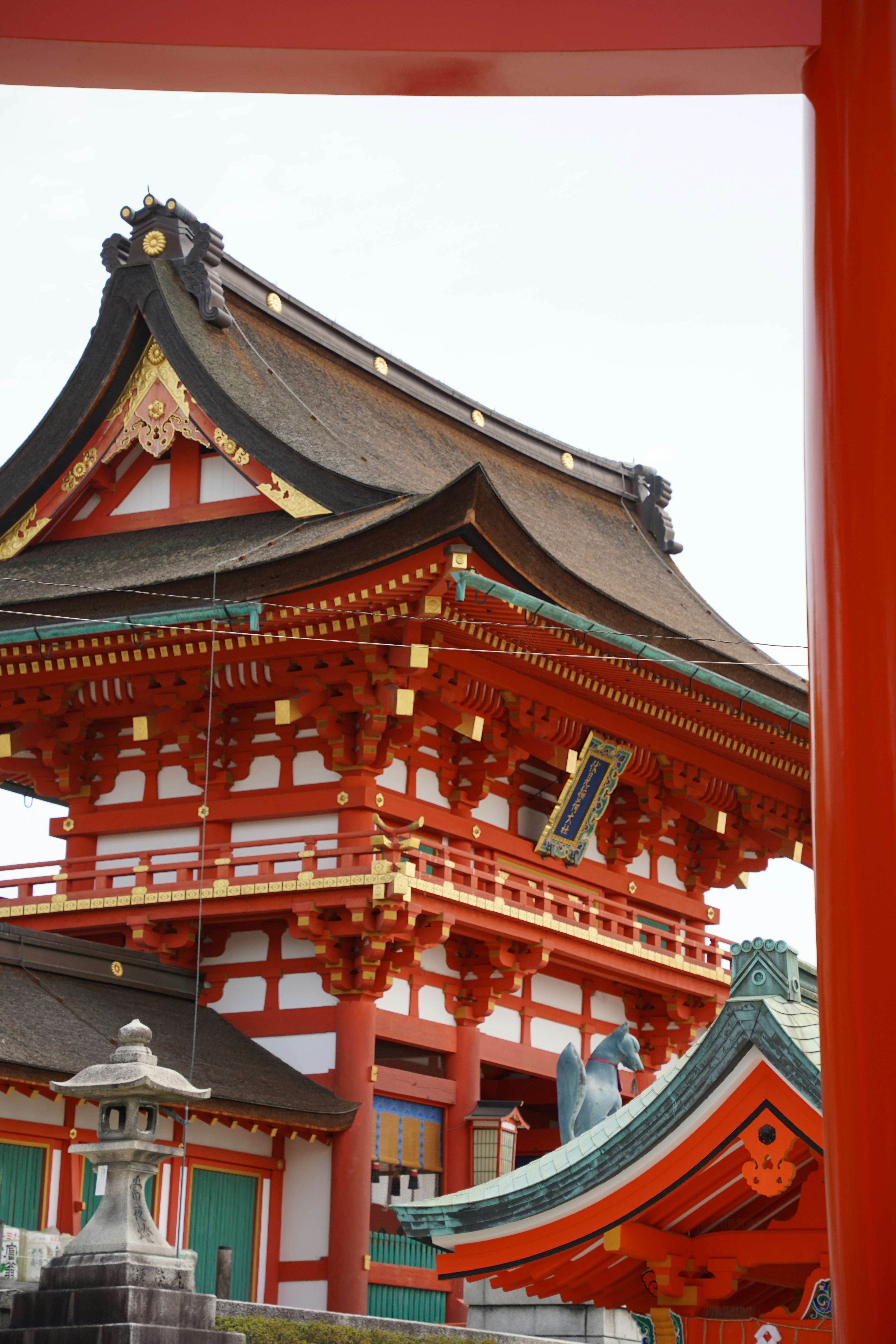 A tall red building sitting next to a tall building photo – Free Kyoto ...