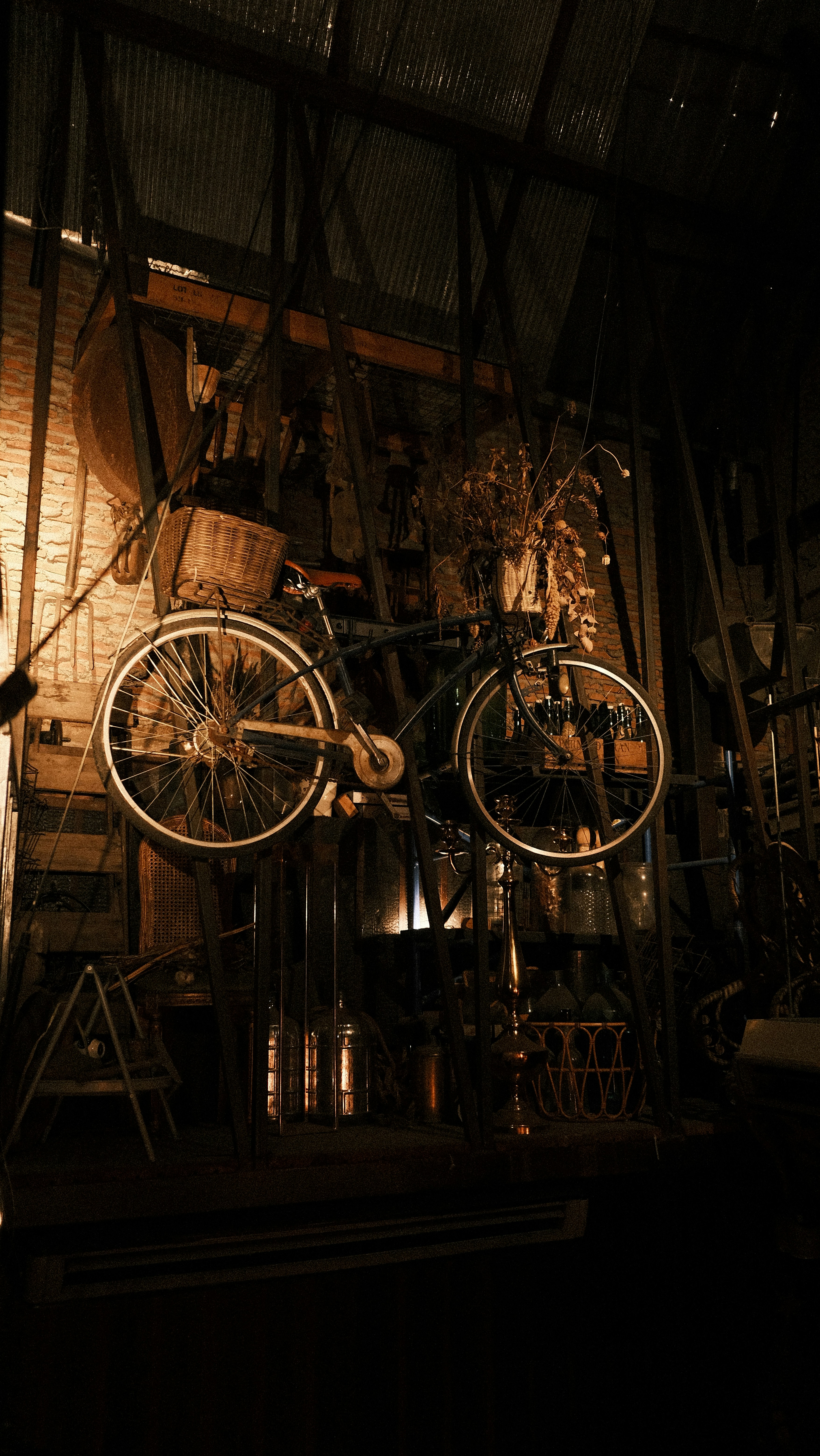 Amber Halo: A Bicycle Suspended in a Dim, Vintage Workshop
