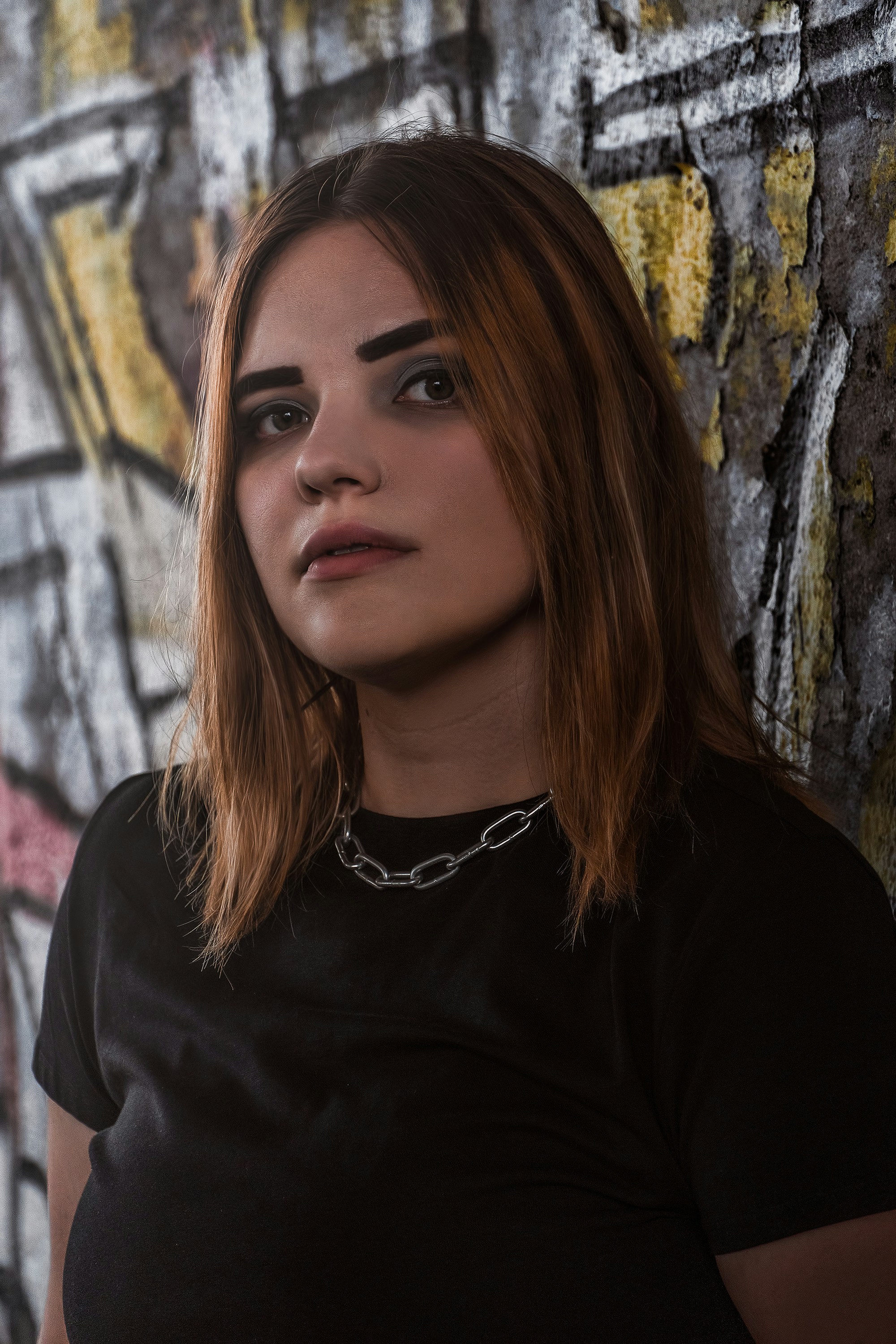 Urban Portrait: Quiet Confidence Against Graffiti Walls