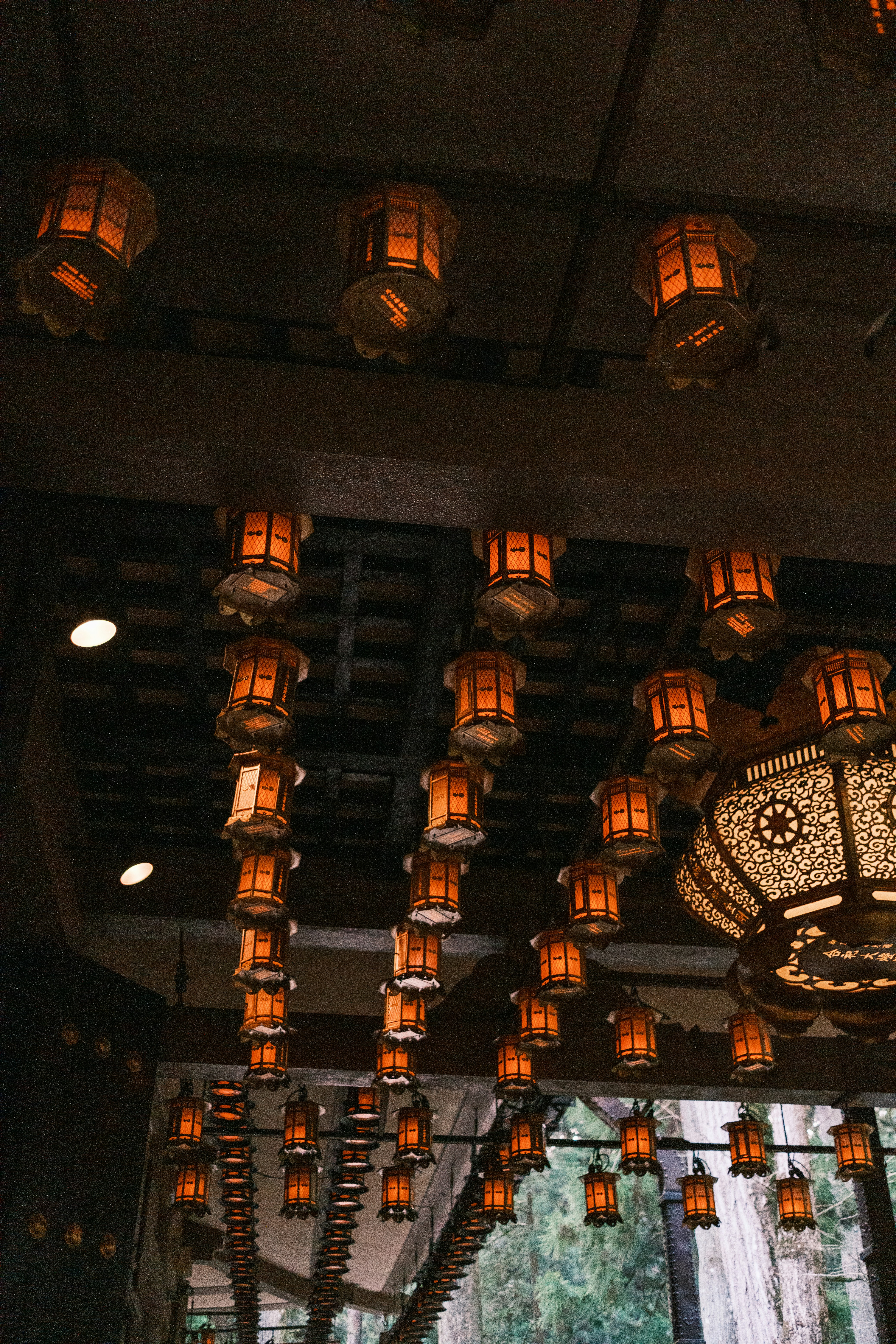 Amber Lantern Rows: A Dim Interior Drenched in Warm Overhead Light
