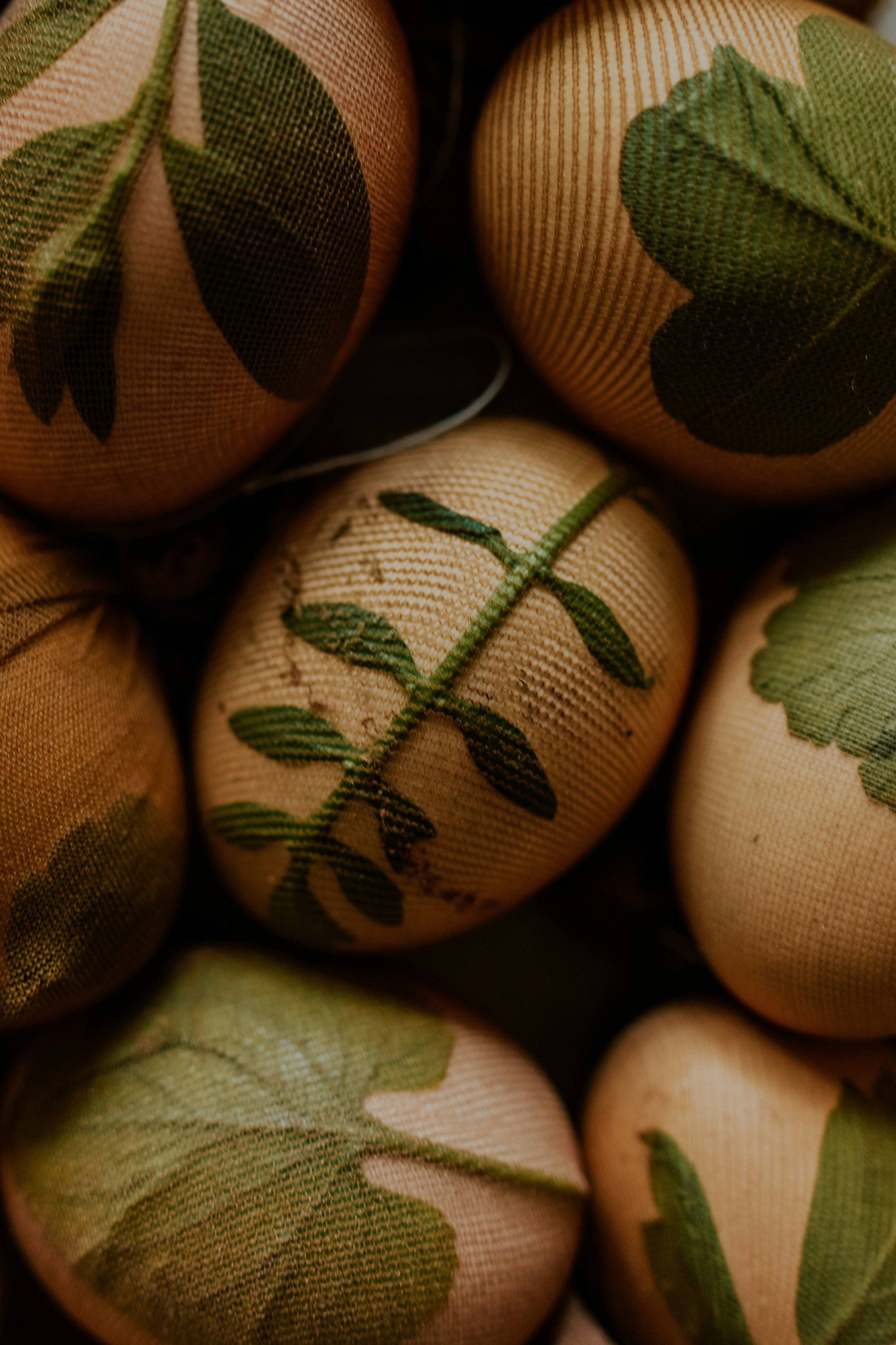 A pile of painted eggs with leaves on them photo – Free Food Image on ...