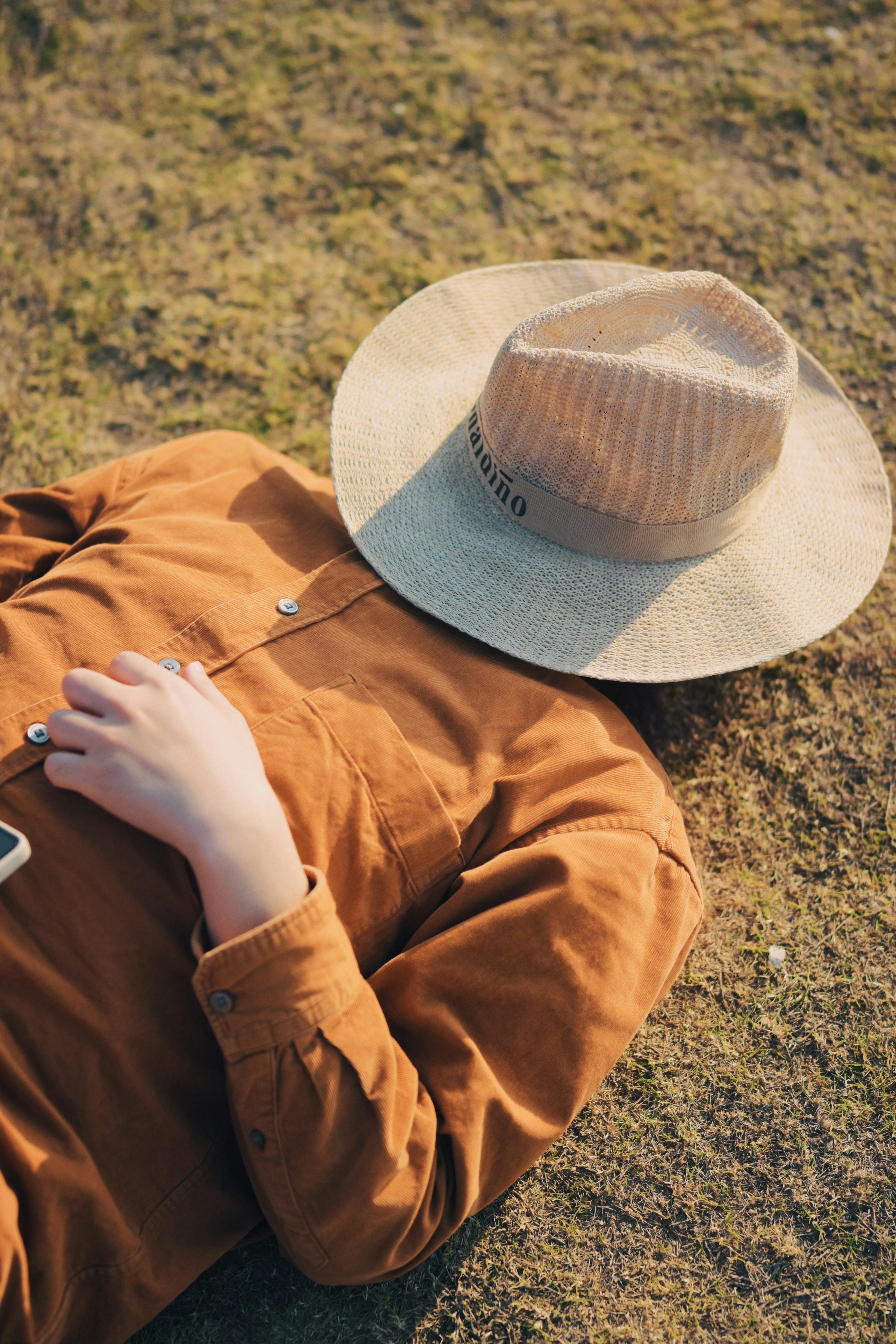 Straw Hat Rest: A Quiet Moment on Sunlit Grass