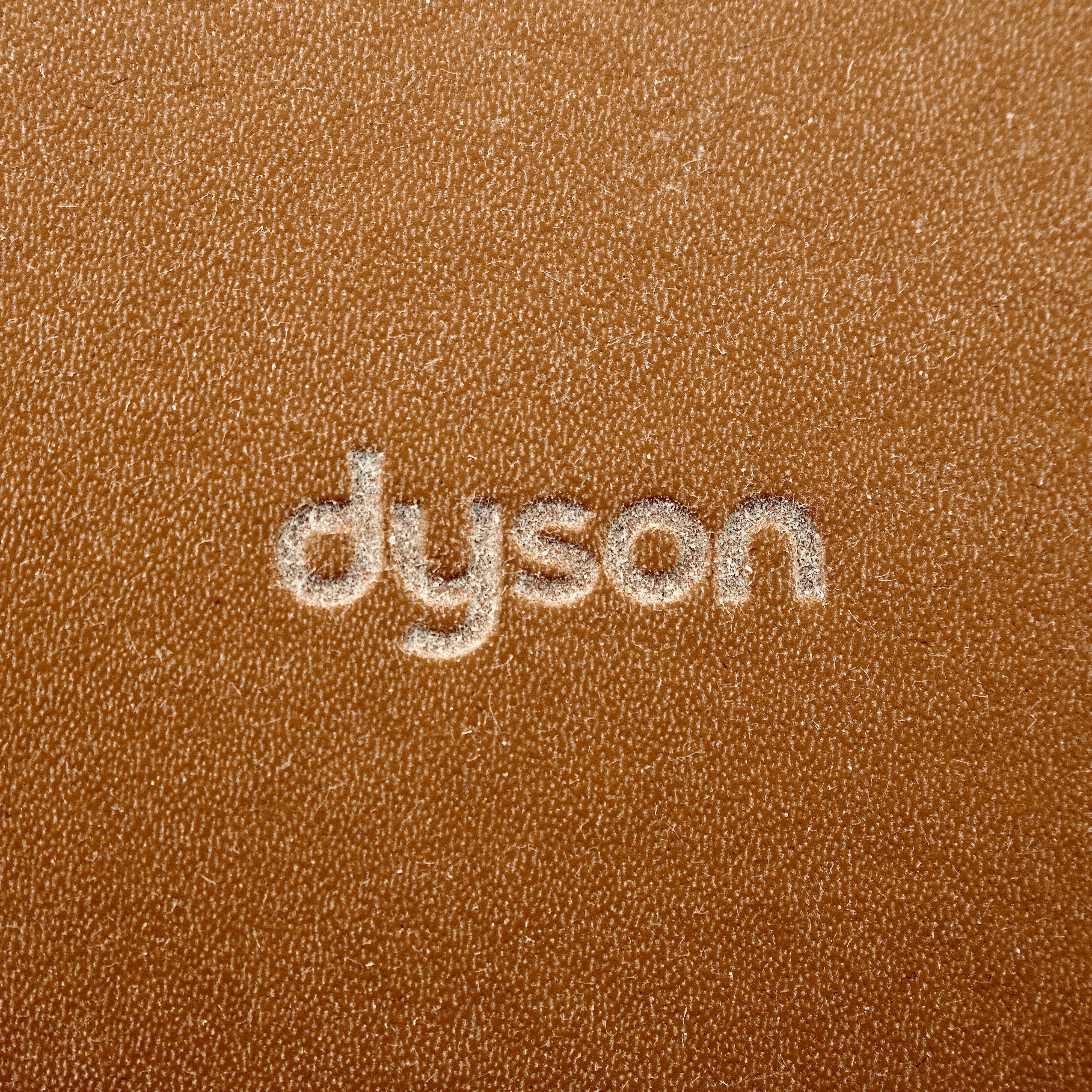 A close up of the word dyson written on a leather surface photo – Free ...