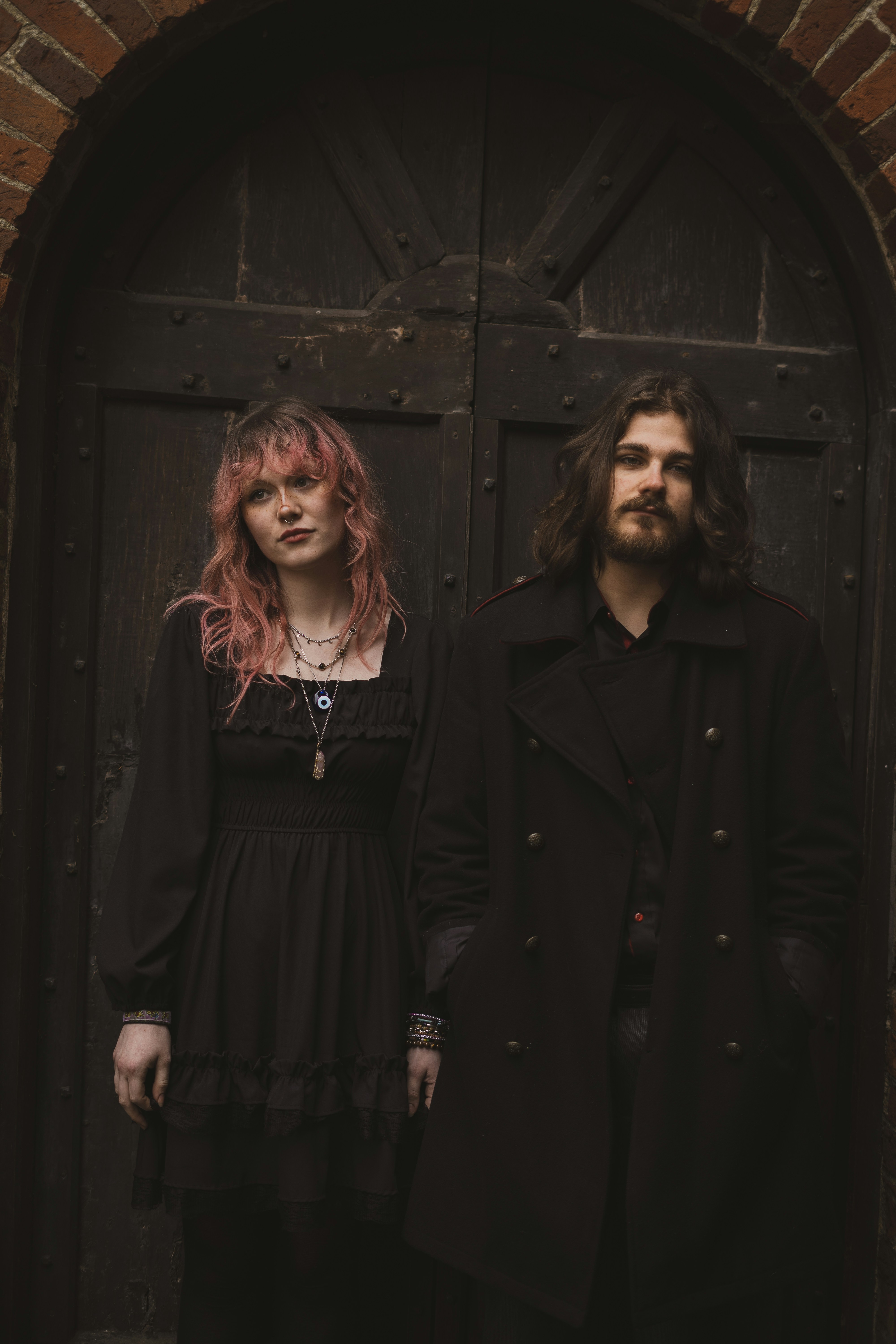 Velvet Shadows at the Archway: A Dual Portrait in Black