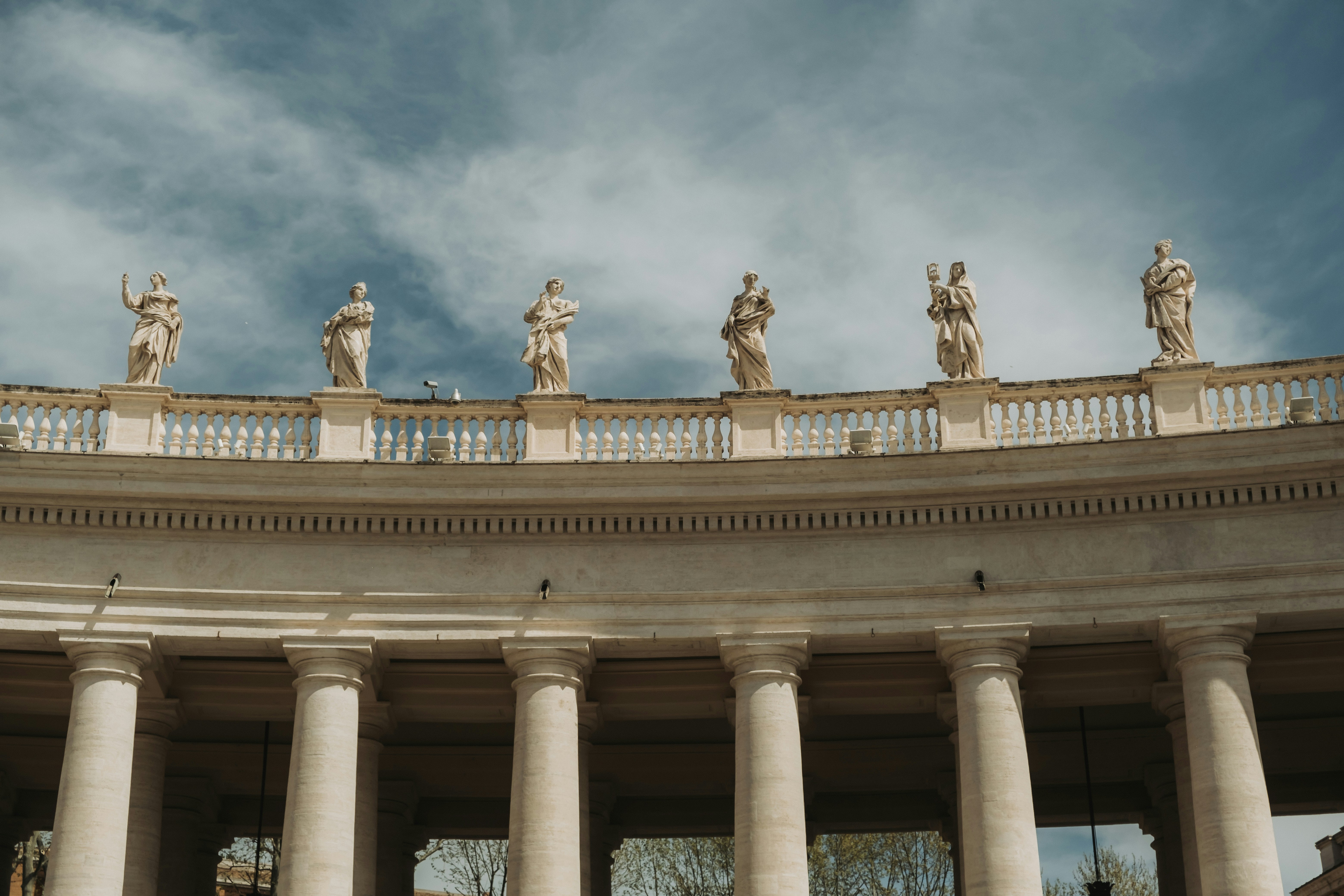Marble Sentinels on the Colonnade under a Cerulean Sky