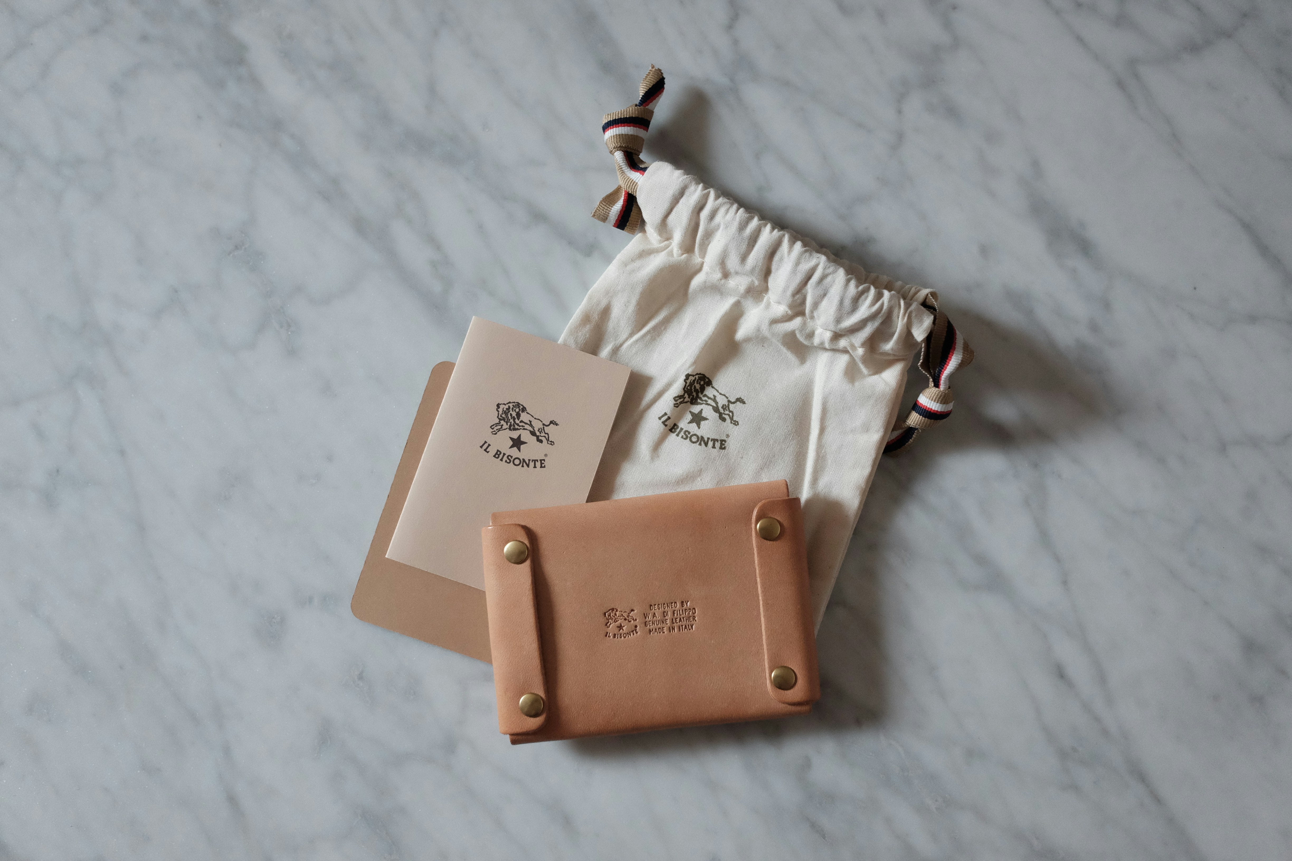 A pair of leather pouches sitting on a marble surface photo – Free ...