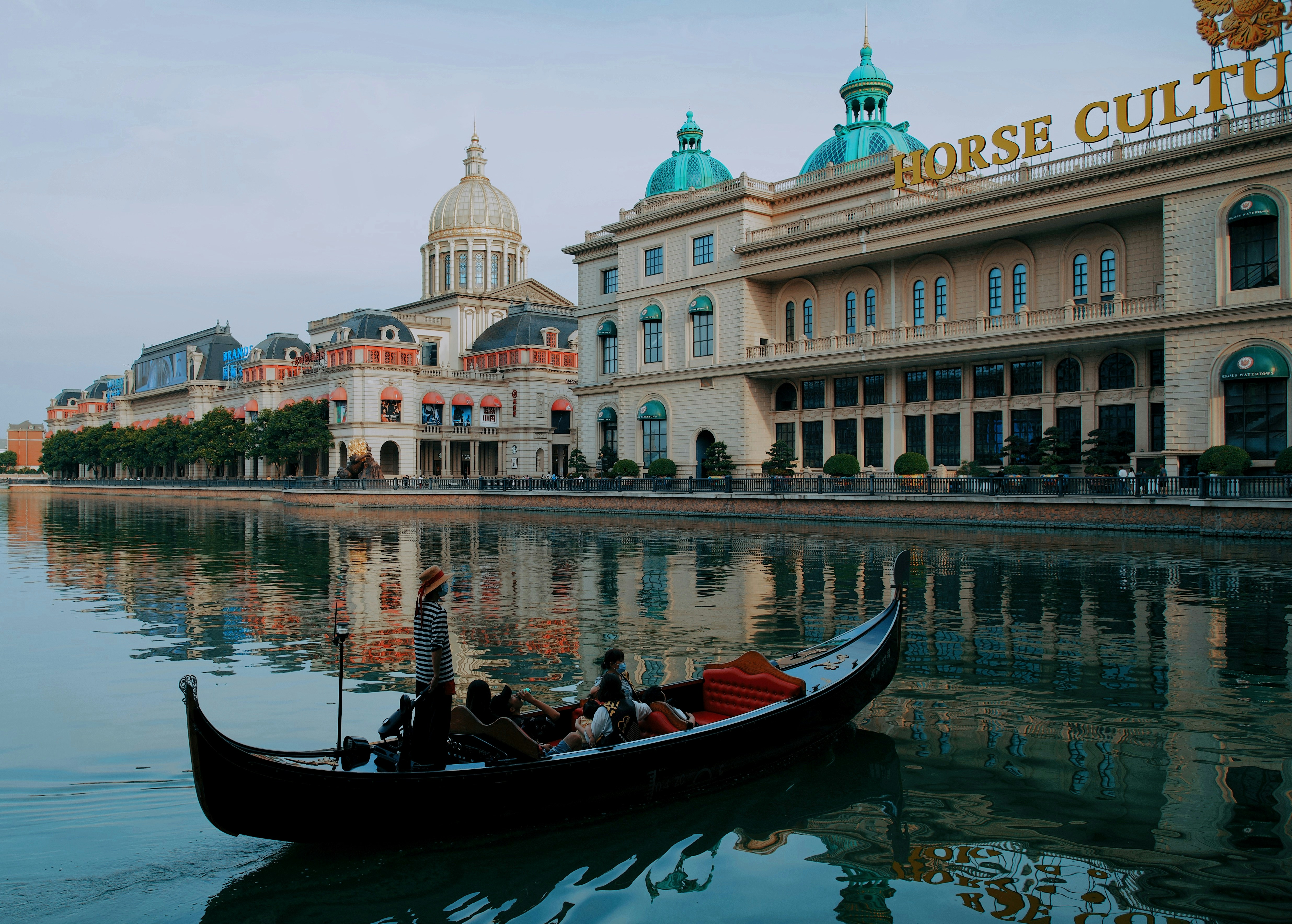 A gondola on the water in front of a building photo – Free Boat Image ...