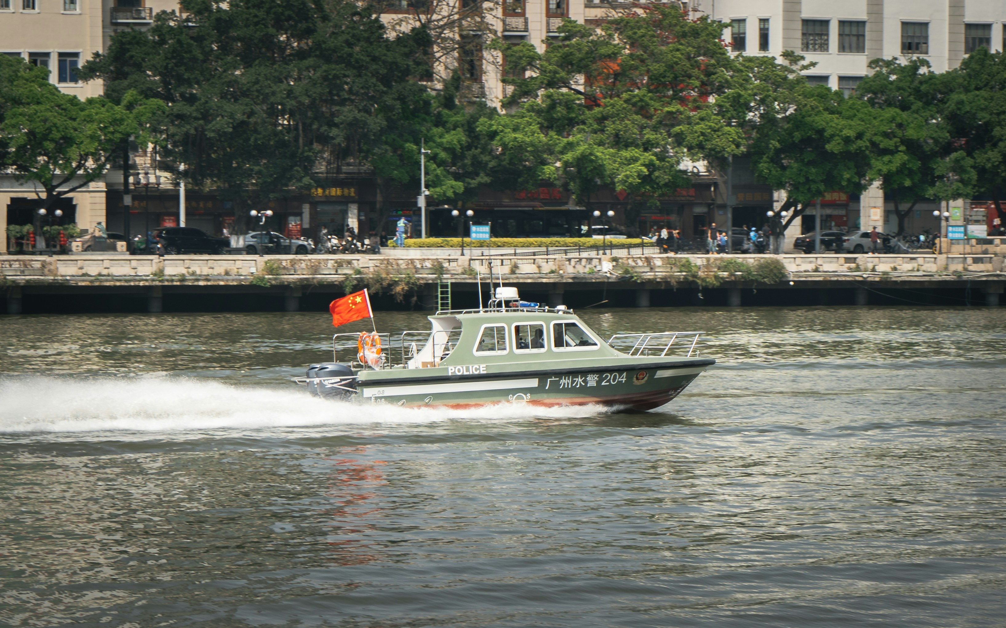 Urban Wake: A Riverside Police Boat in Full Pursuit