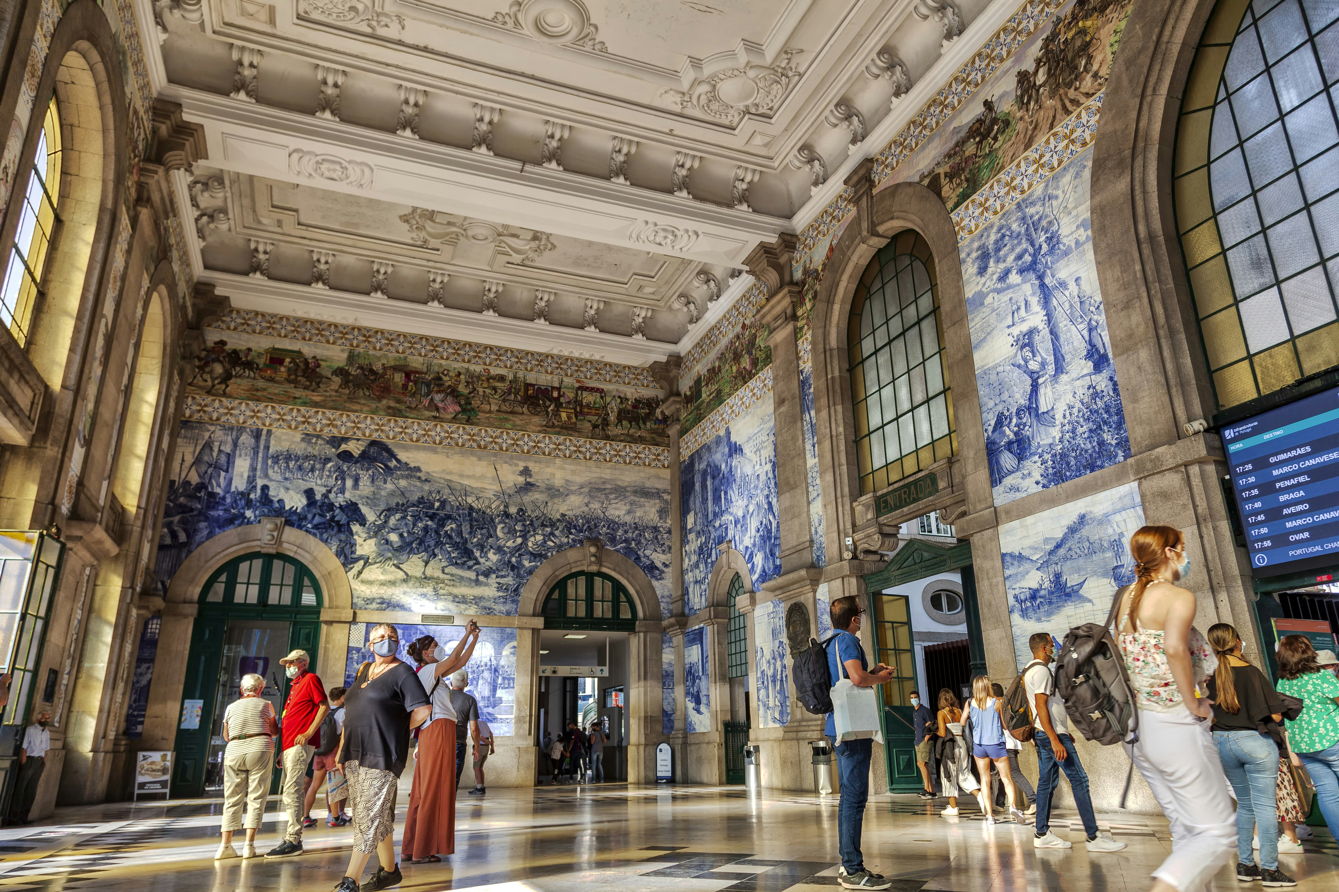 a group of people walking around a building
