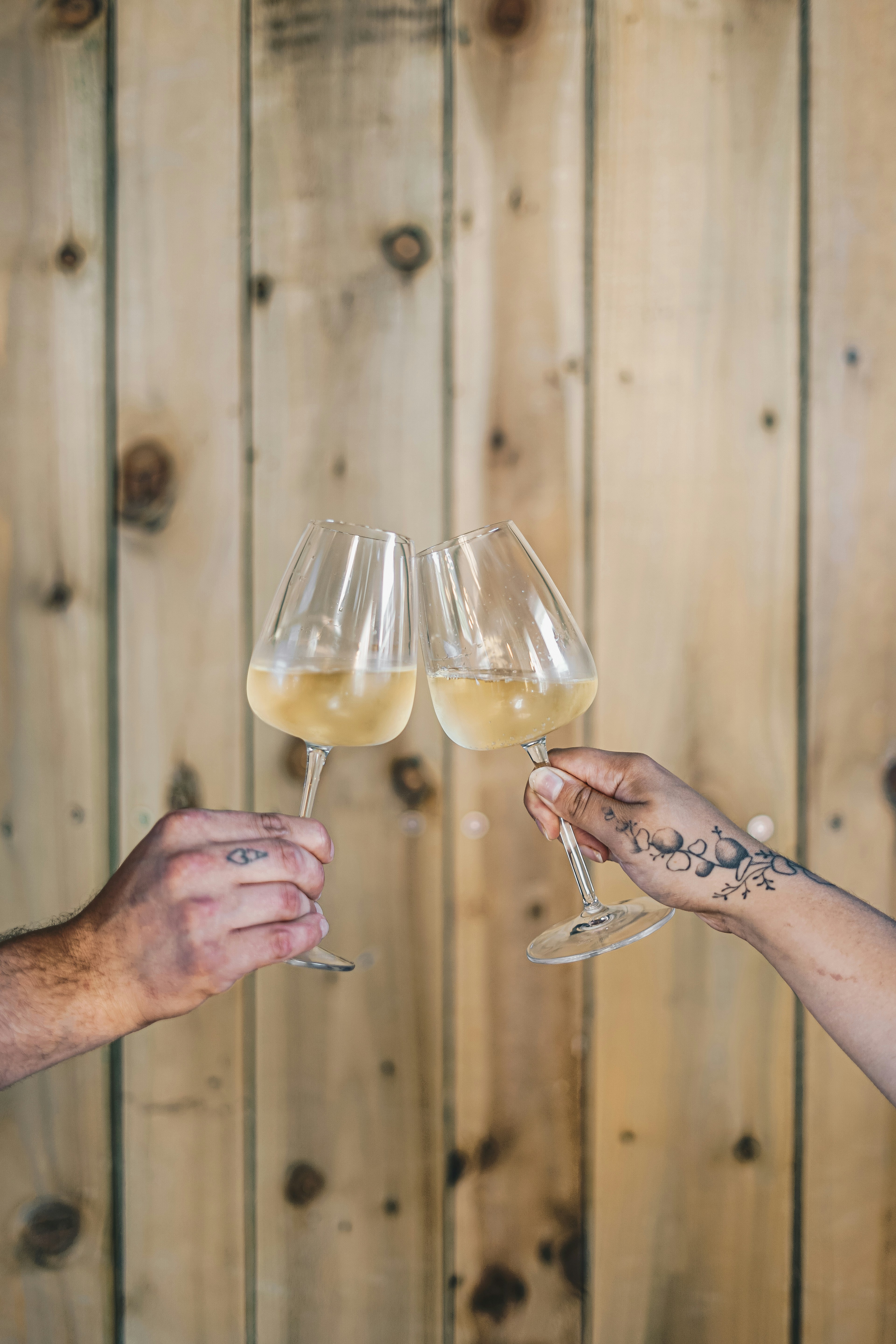 Toast in Weathered Light: Two Glasses Clink in Quiet Celebration
