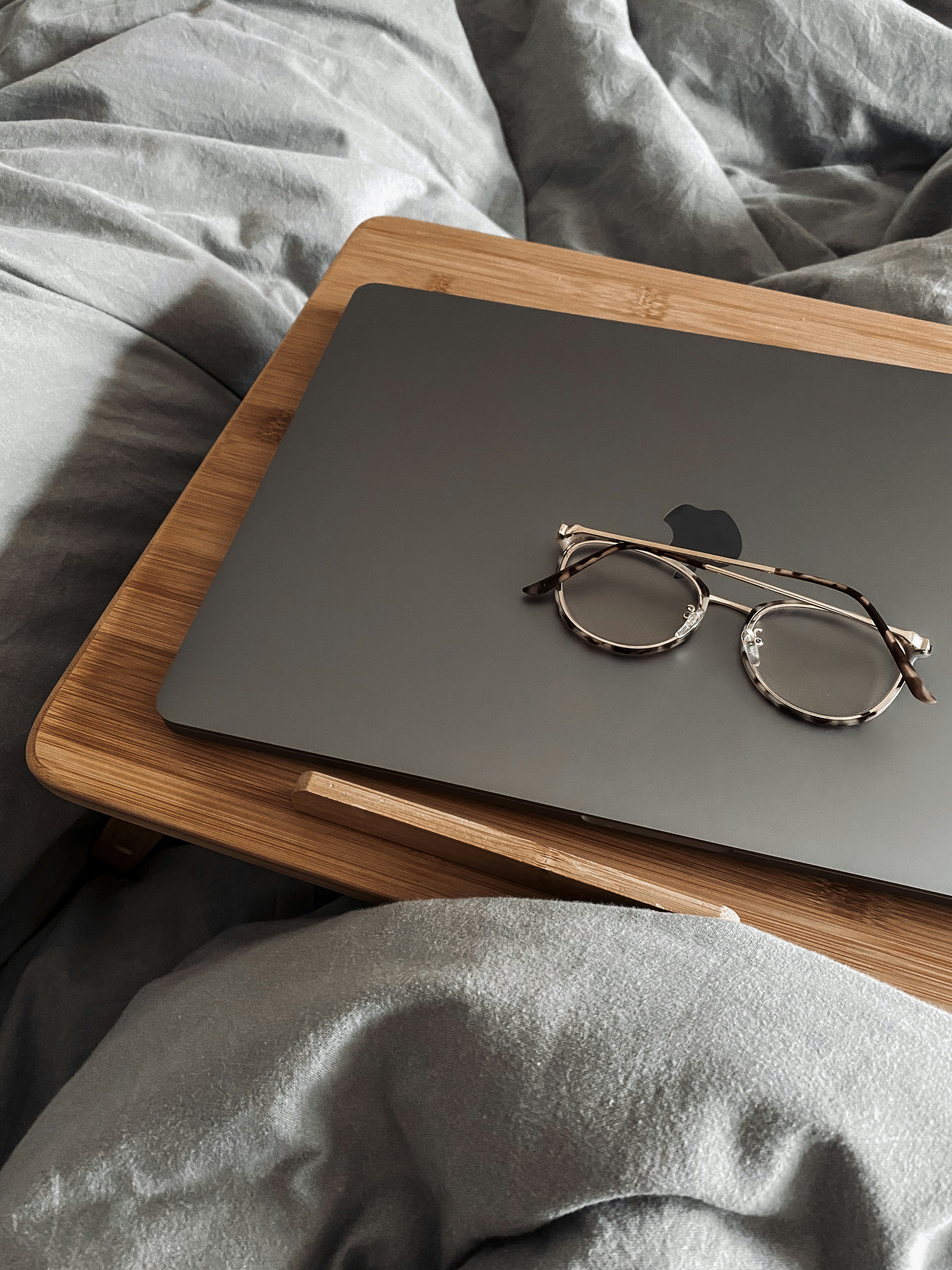 Quiet Focus: Eyeglasses Rest on a Closed MacBook