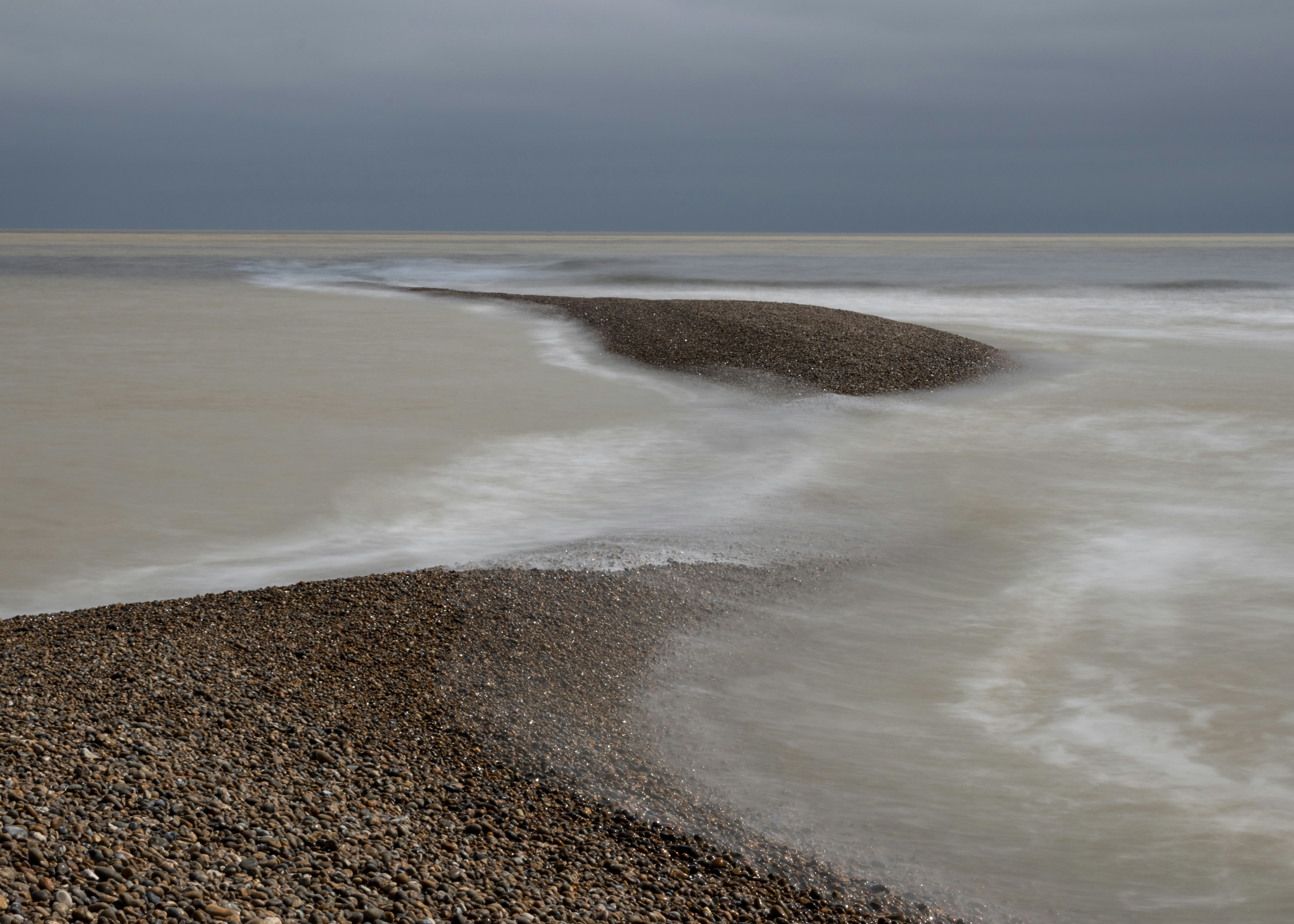 Pebble Spit: A Quiet Channel Piercing a Muted Sea