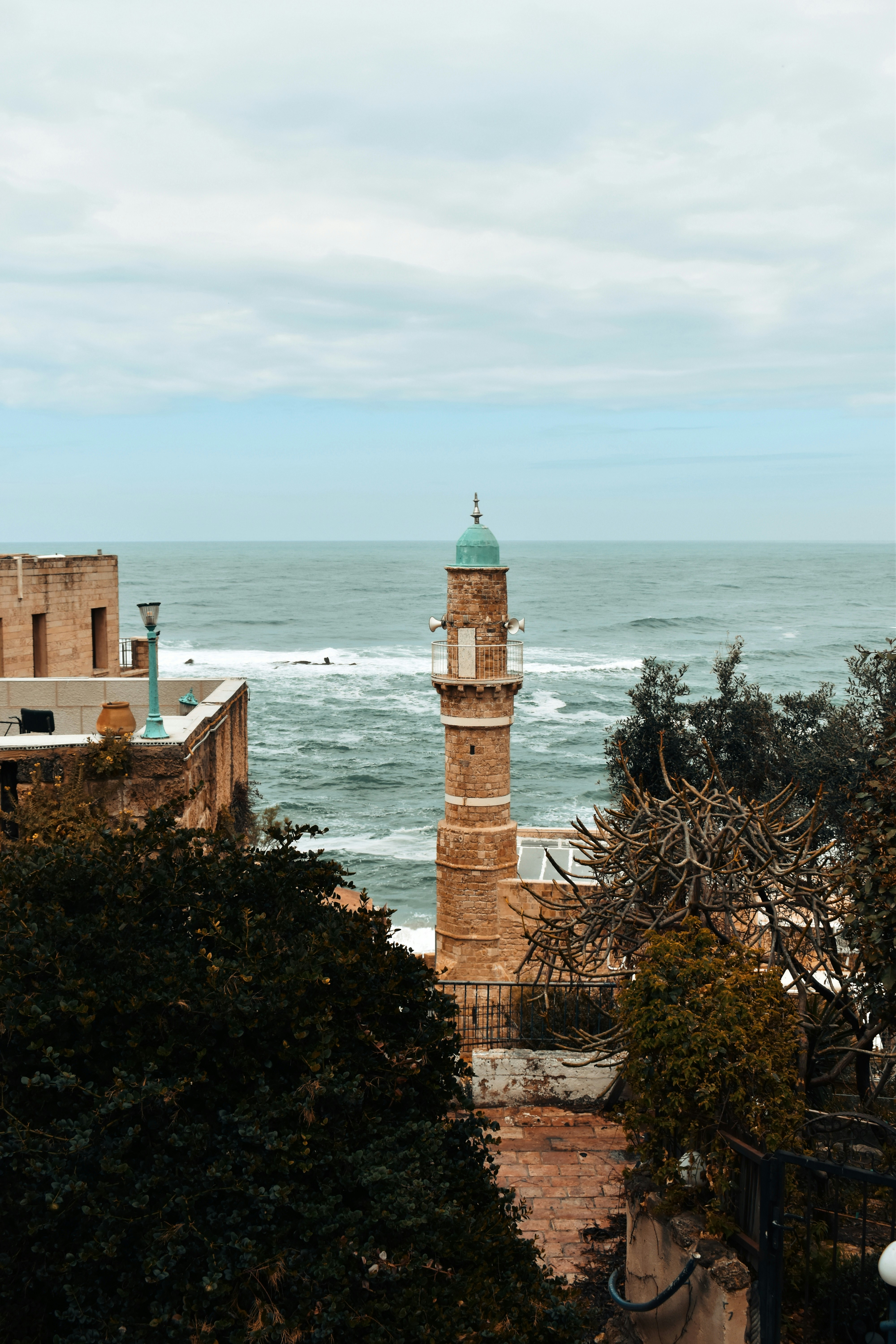 A clock tower sitting next to the ocean photo – Free Israël Image on ...