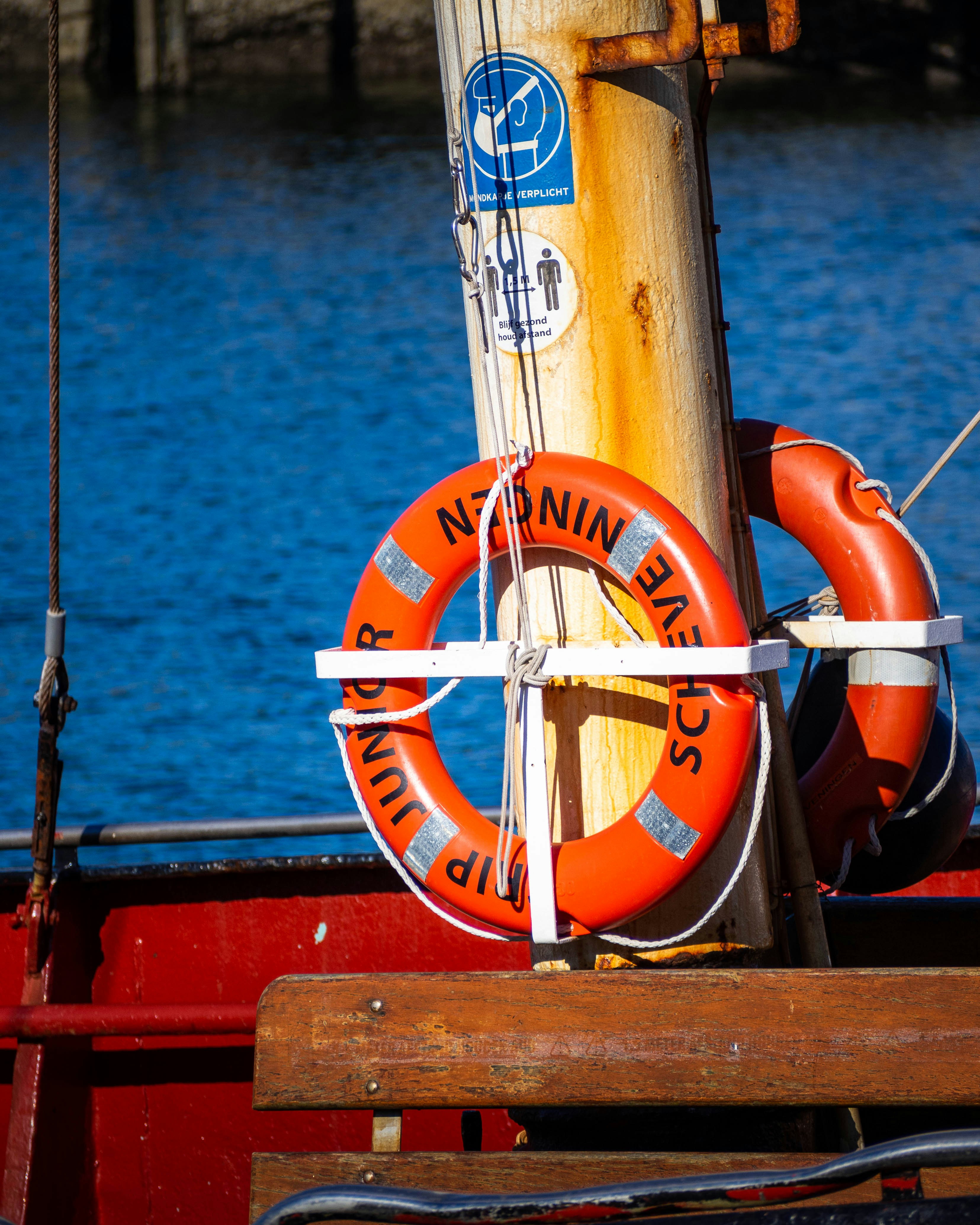 A life preserver on a boat in the water photo – Free Water Image on ...