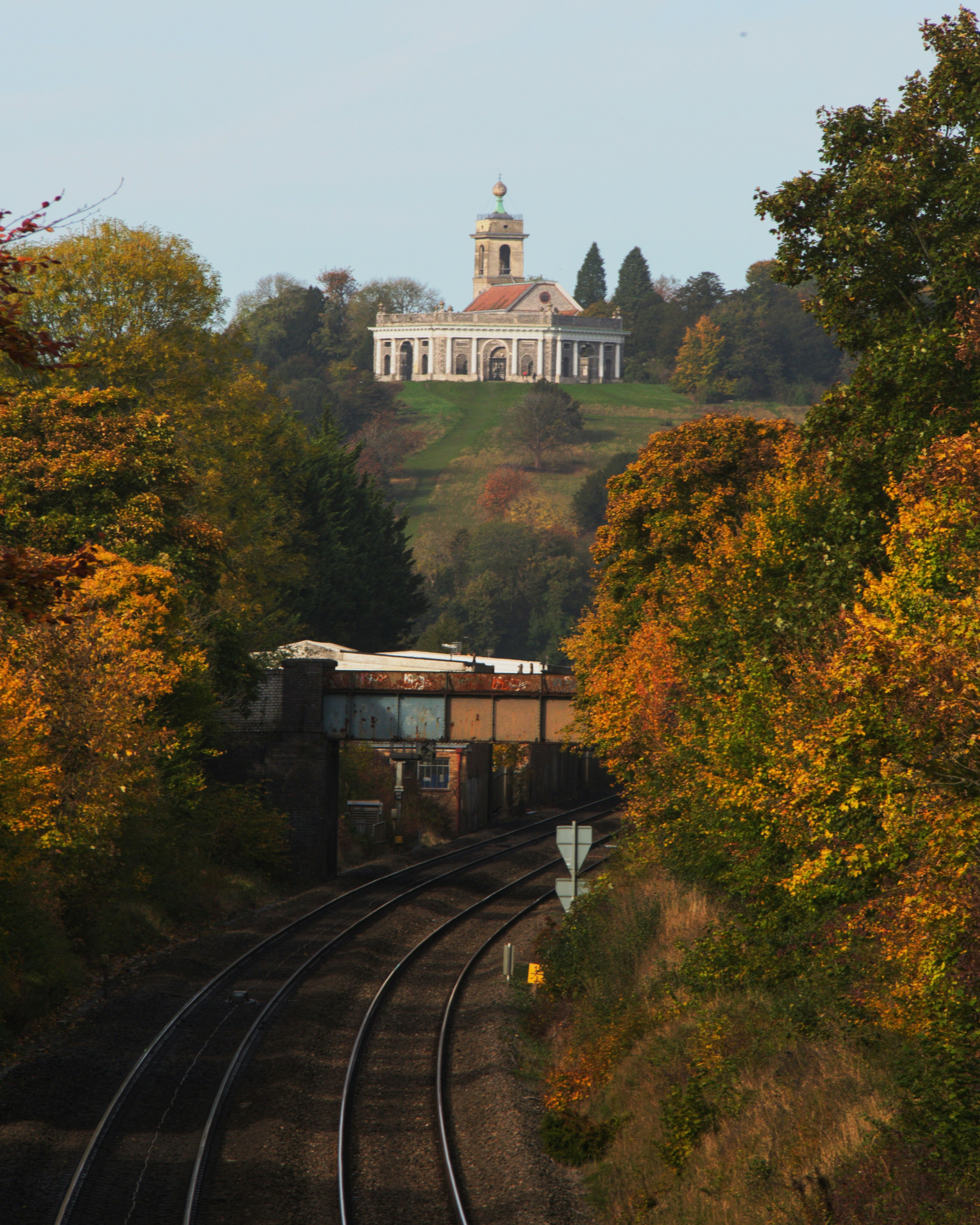 Autumn Summit: The Hilltop Rotunda Framed by a Winding Railway