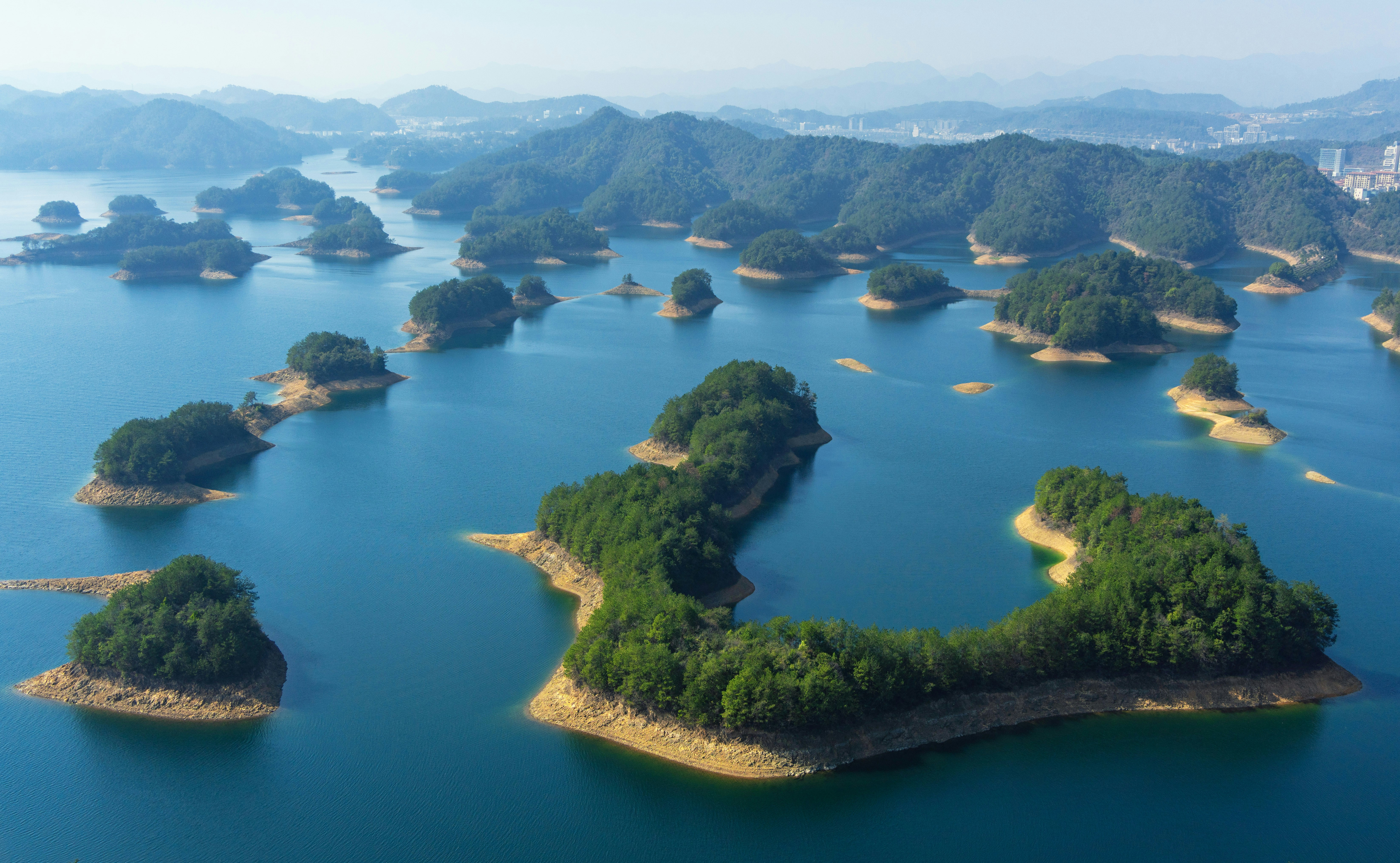 A large body of water surrounded by trees photo – Free Qiandao lake ...