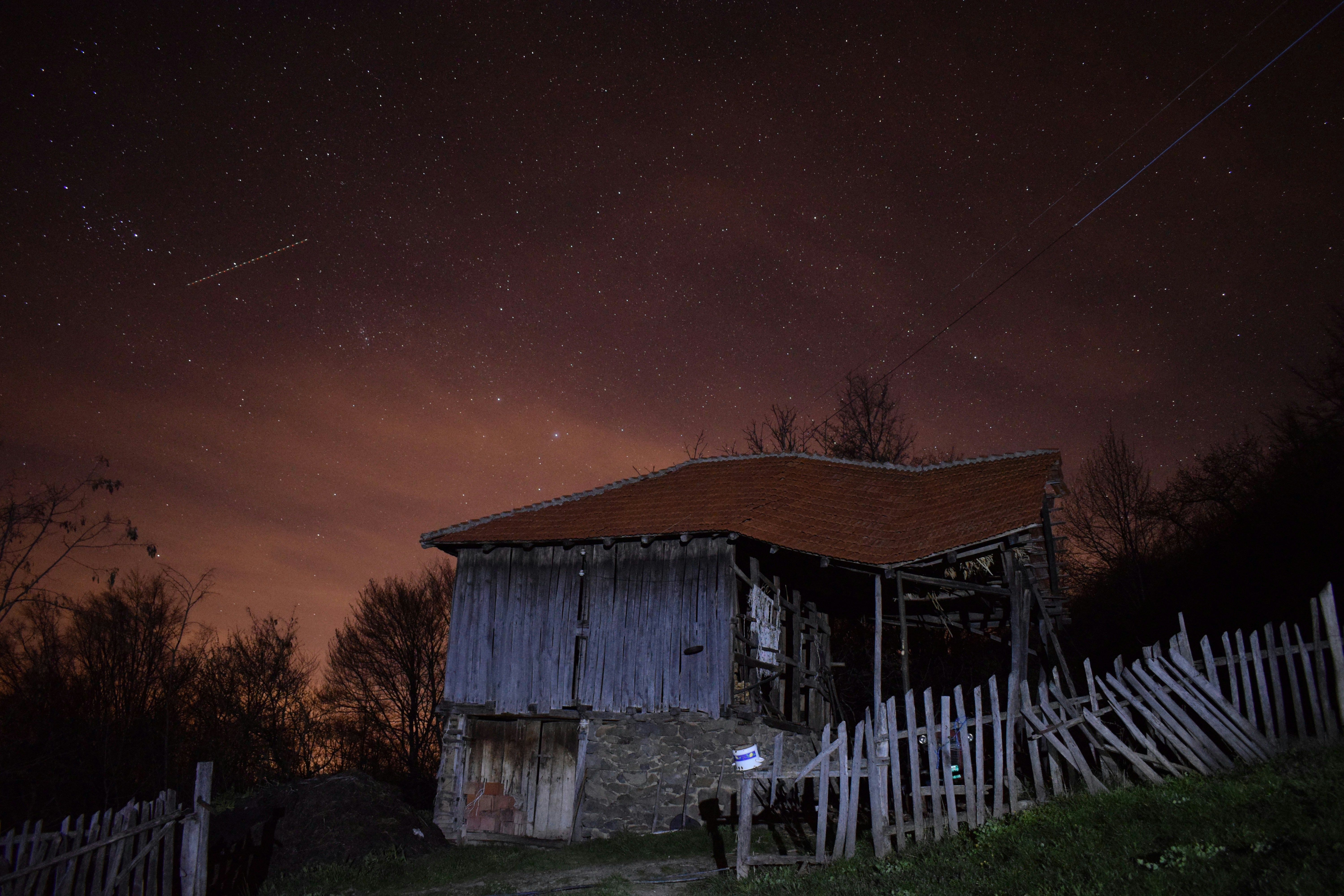 Meteor Trails Over the Weathered Shed on a Quiet Ridge
