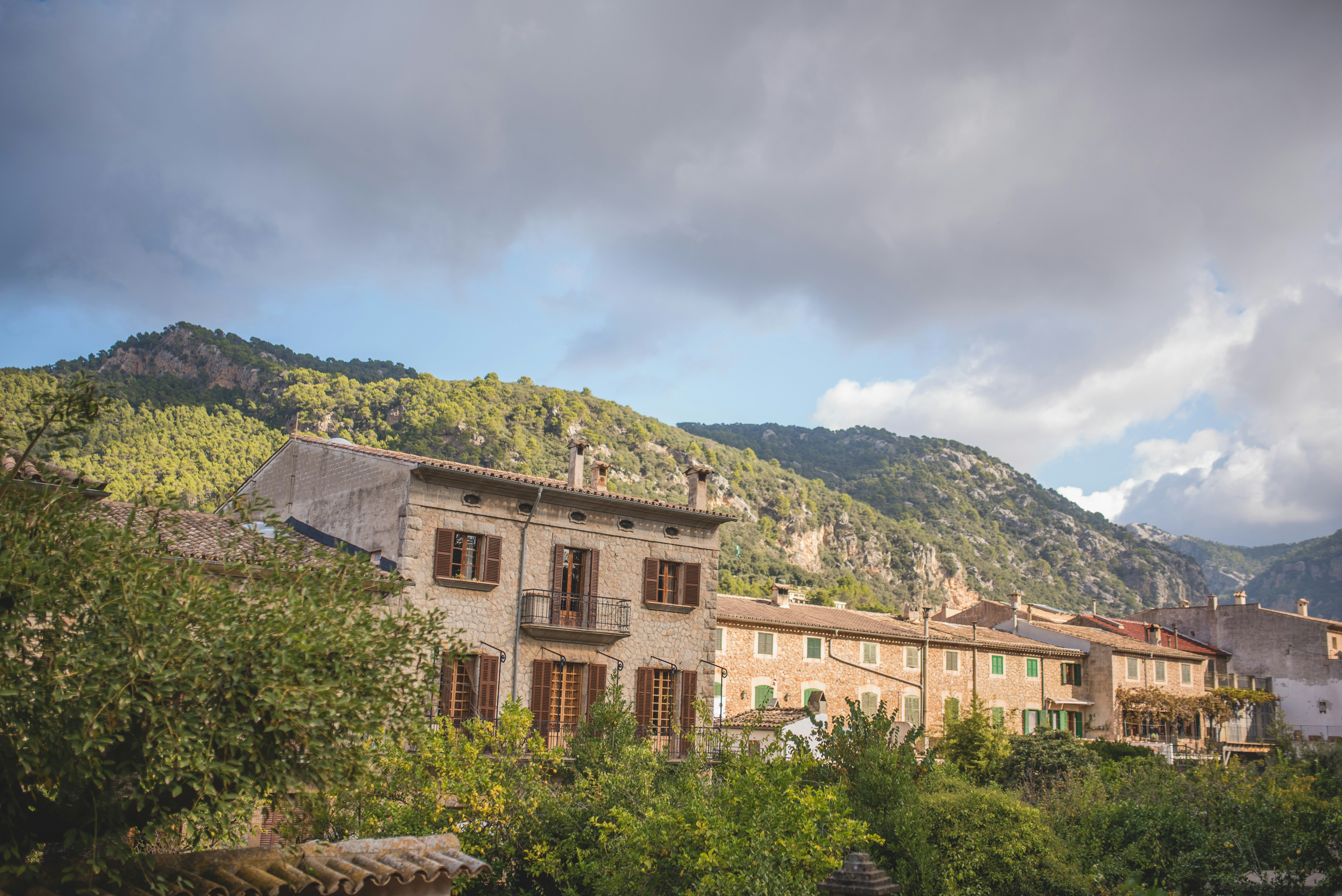 A row of buildings on the side of a mountain photo – Free Mallorca ...