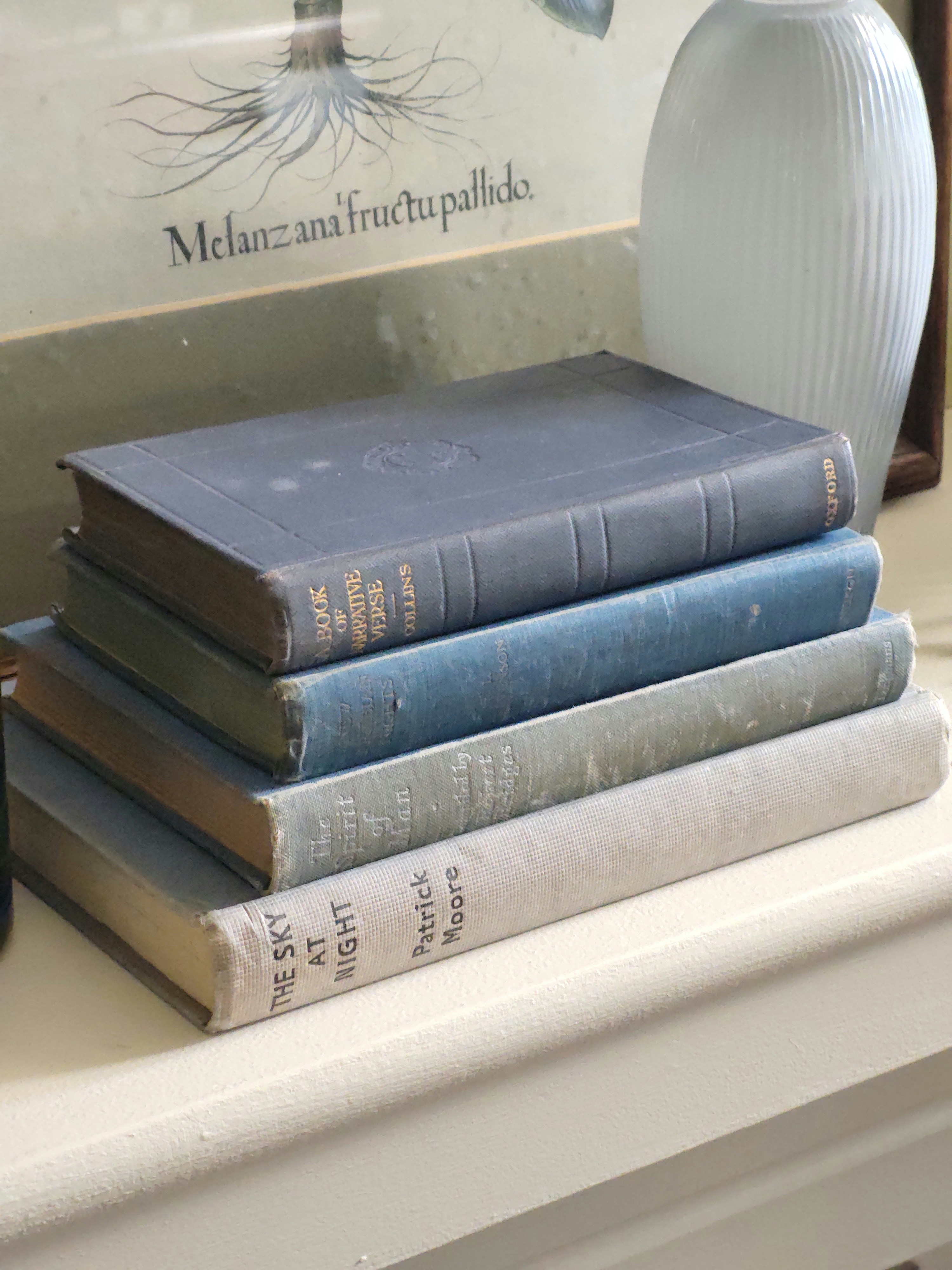 Bluebound Treasures: A Quiet Stack of Vintage Books on a Sill