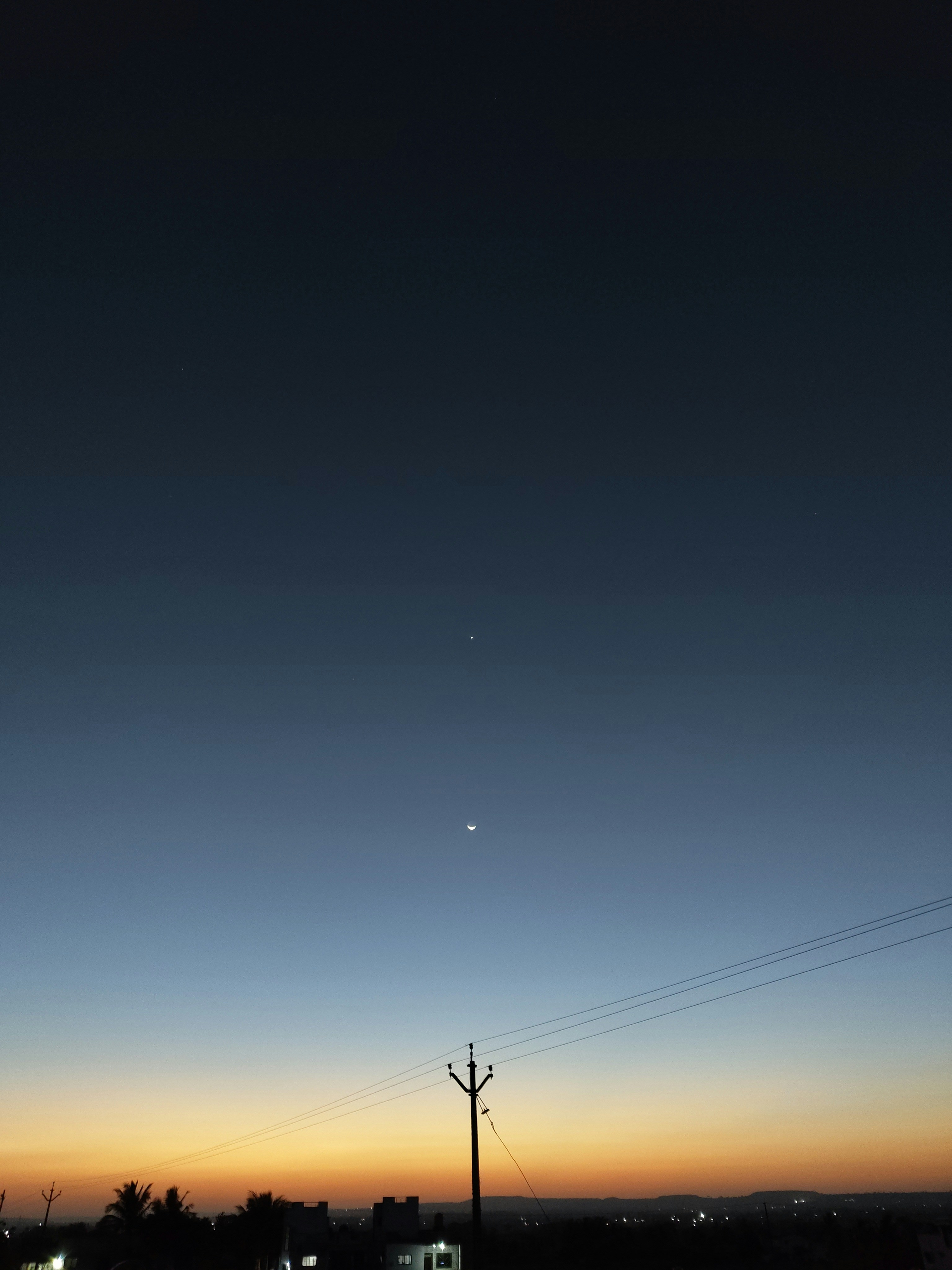 The sun is setting over a city with power lines photo – Free Moon and ...