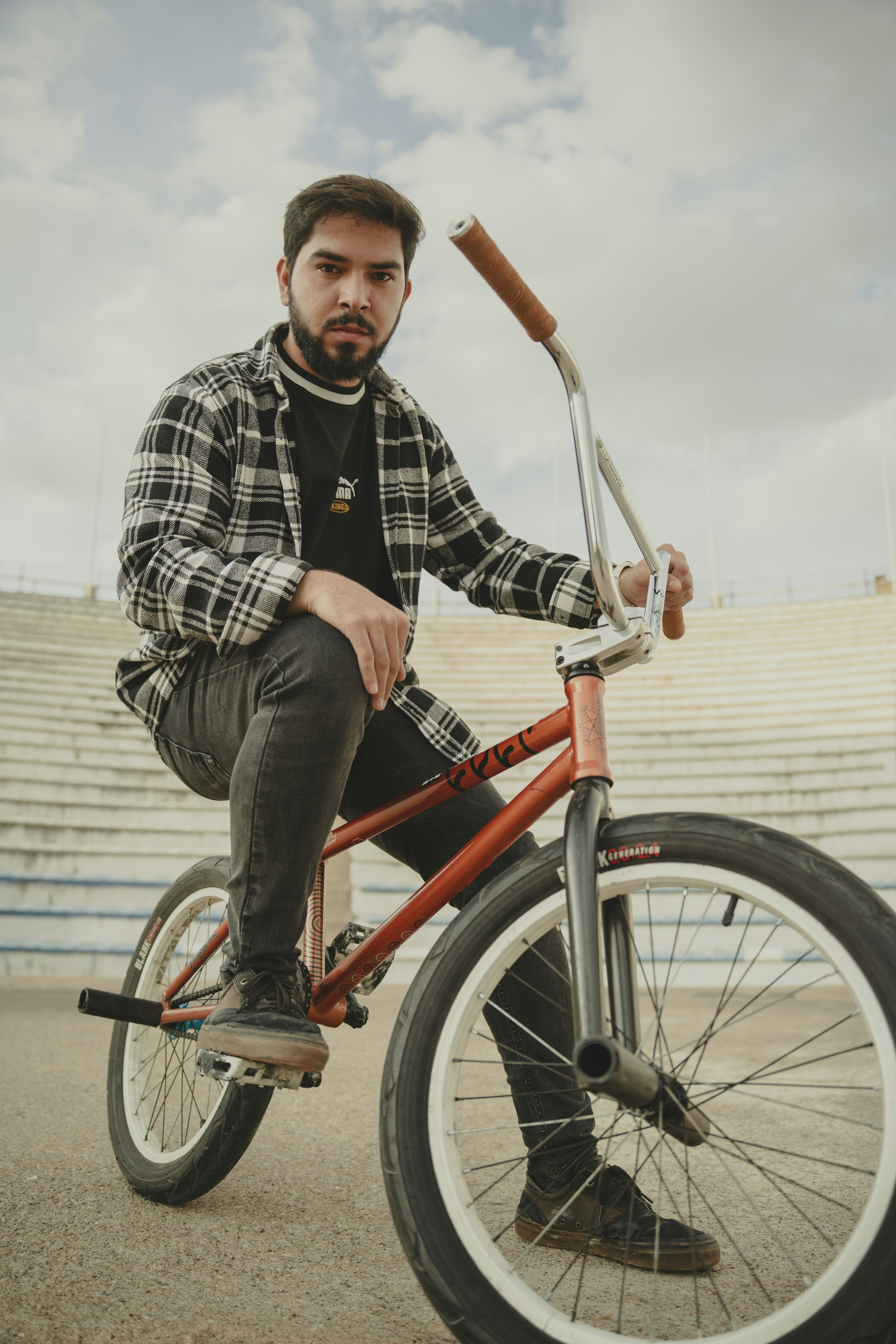 Quiet Arena, Bold Ride: BMX Portrait on Weathered Stadium Steps