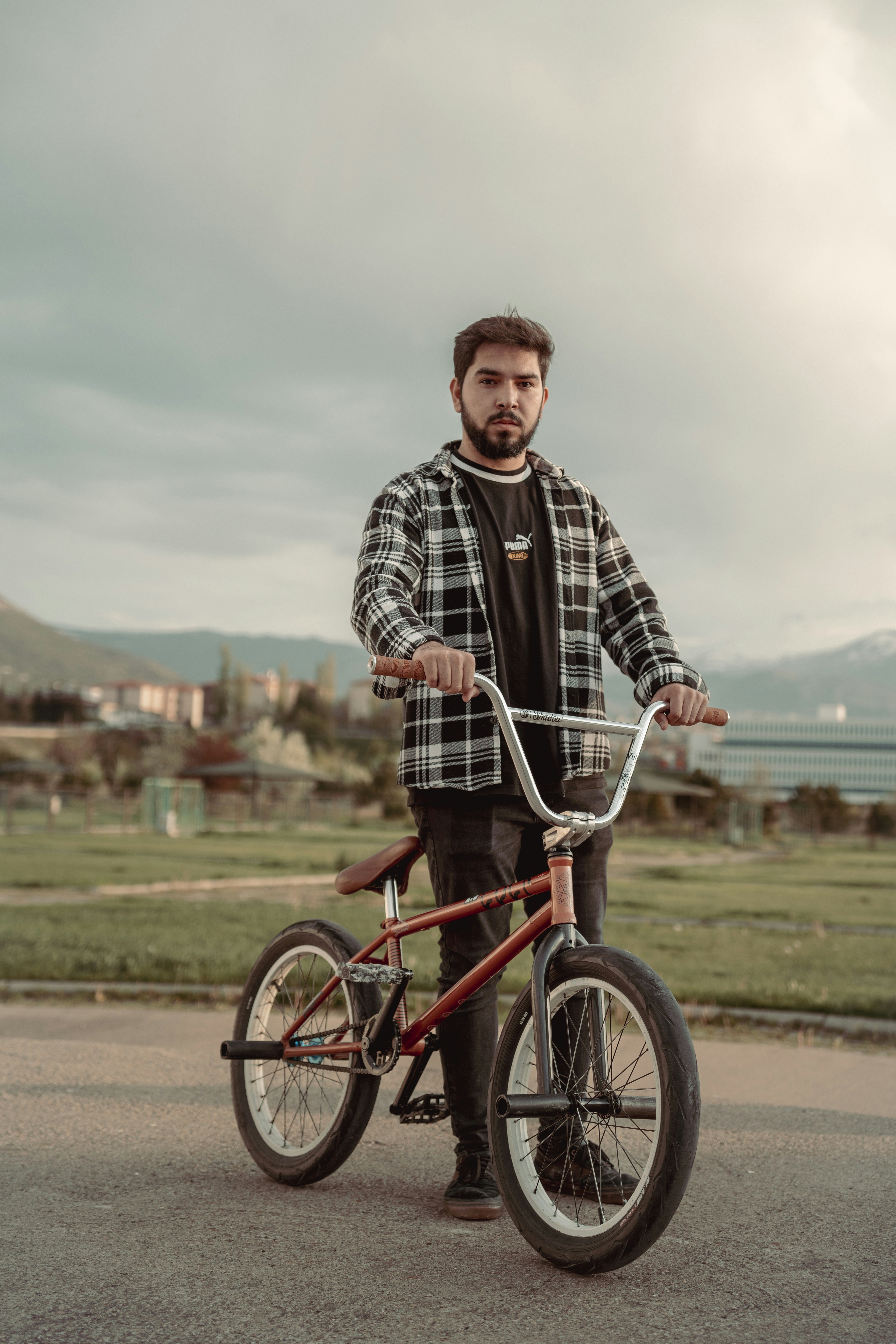 Cyclist Emerges from the Park with Quiet Confidence