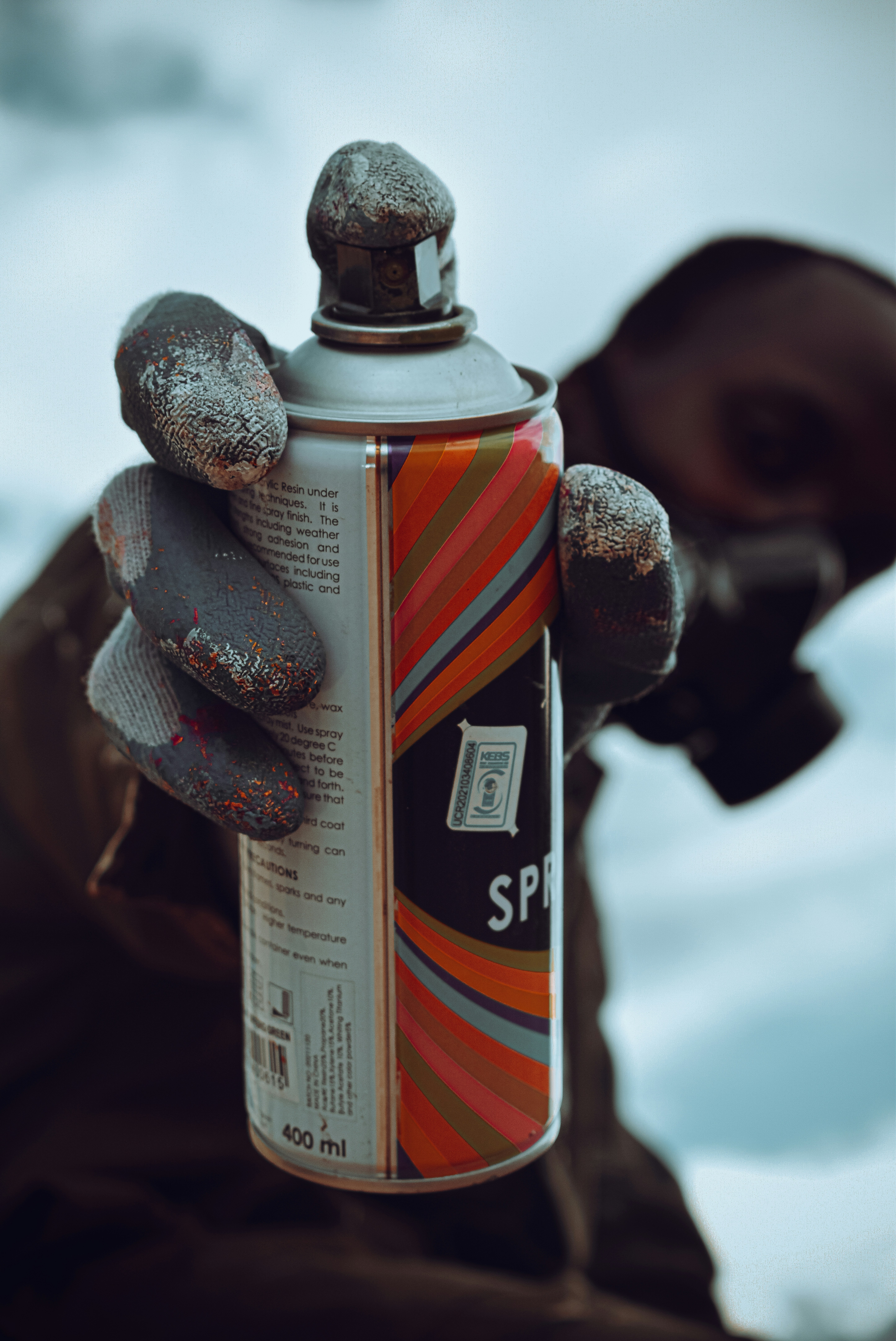 Masked Grip, Neon Stripes: A Close-Up Graffiti Moment in Snow