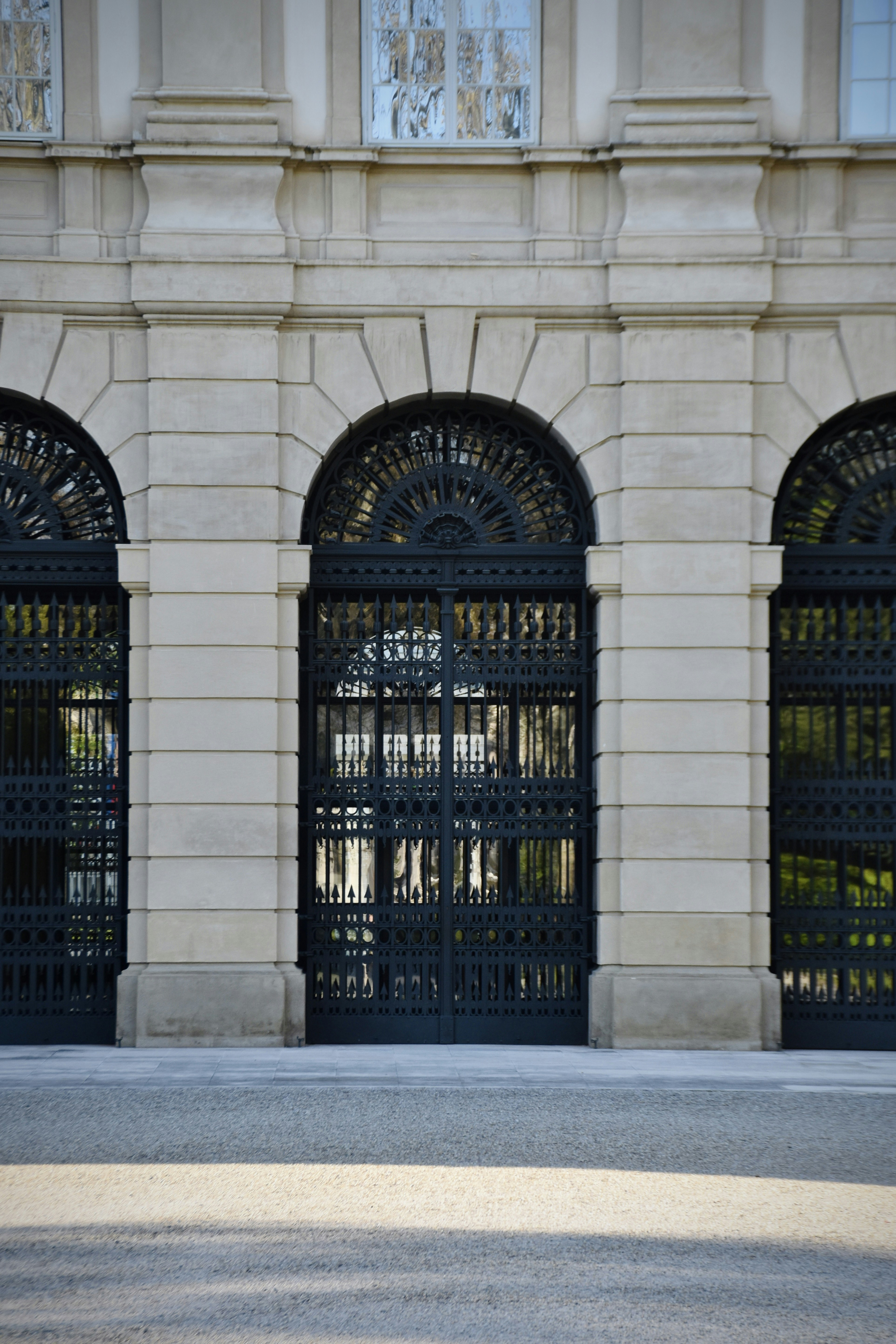 A man riding a skateboard down a street next to a tall building photo ...