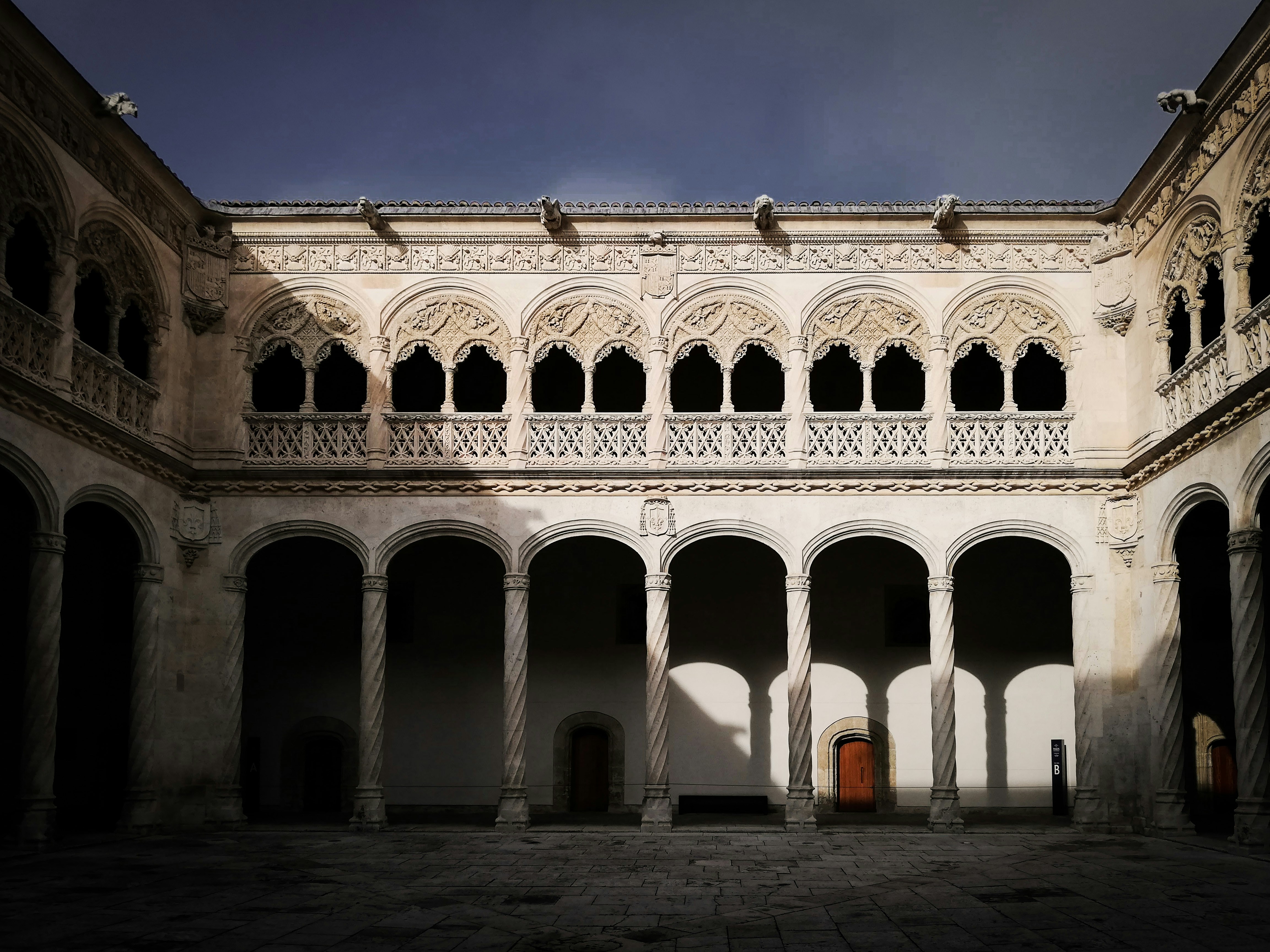 A large building with arches and arches around it photo – Free Building ...