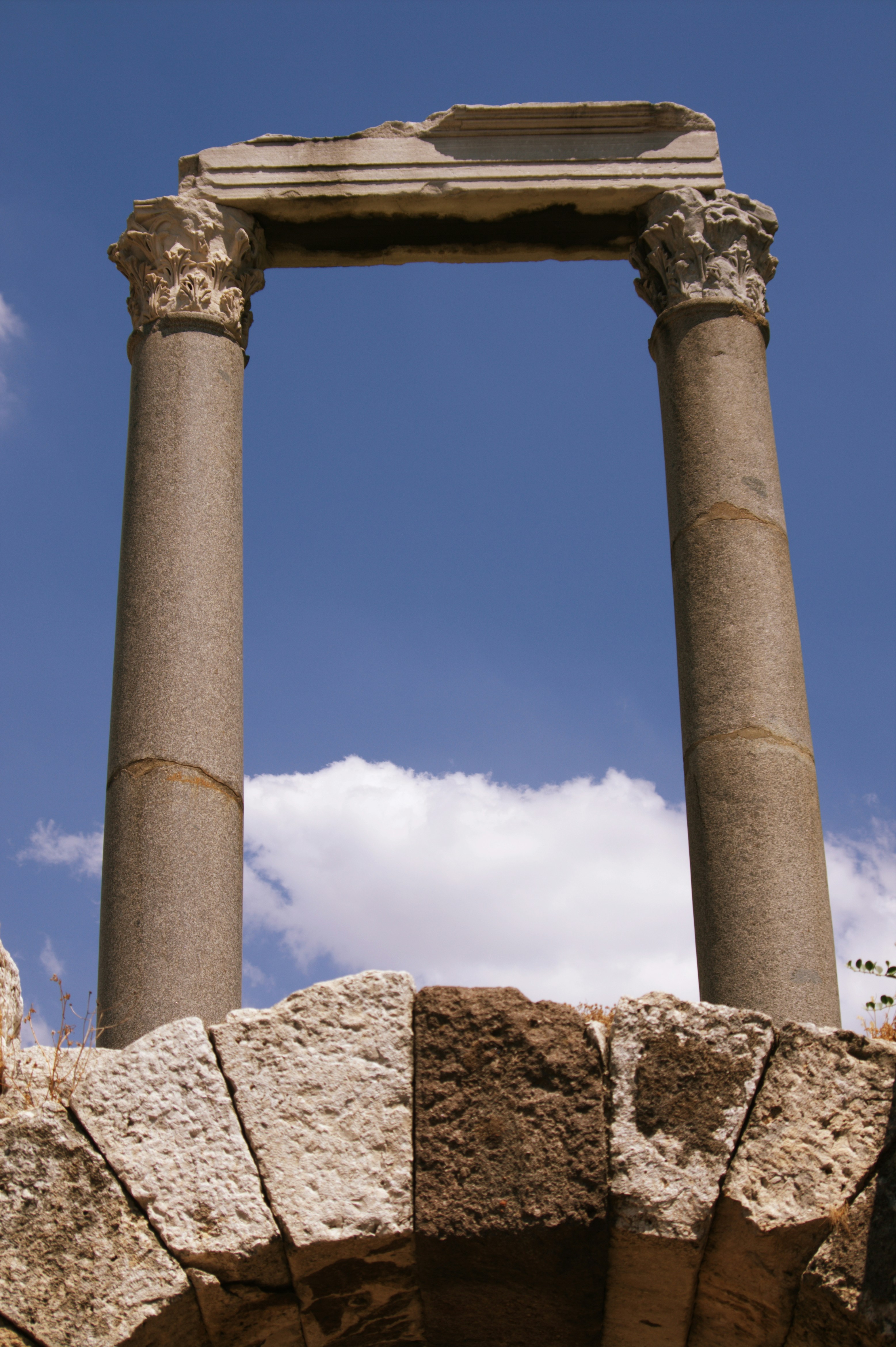 A large stone structure with two pillars in the middle of it photo ...