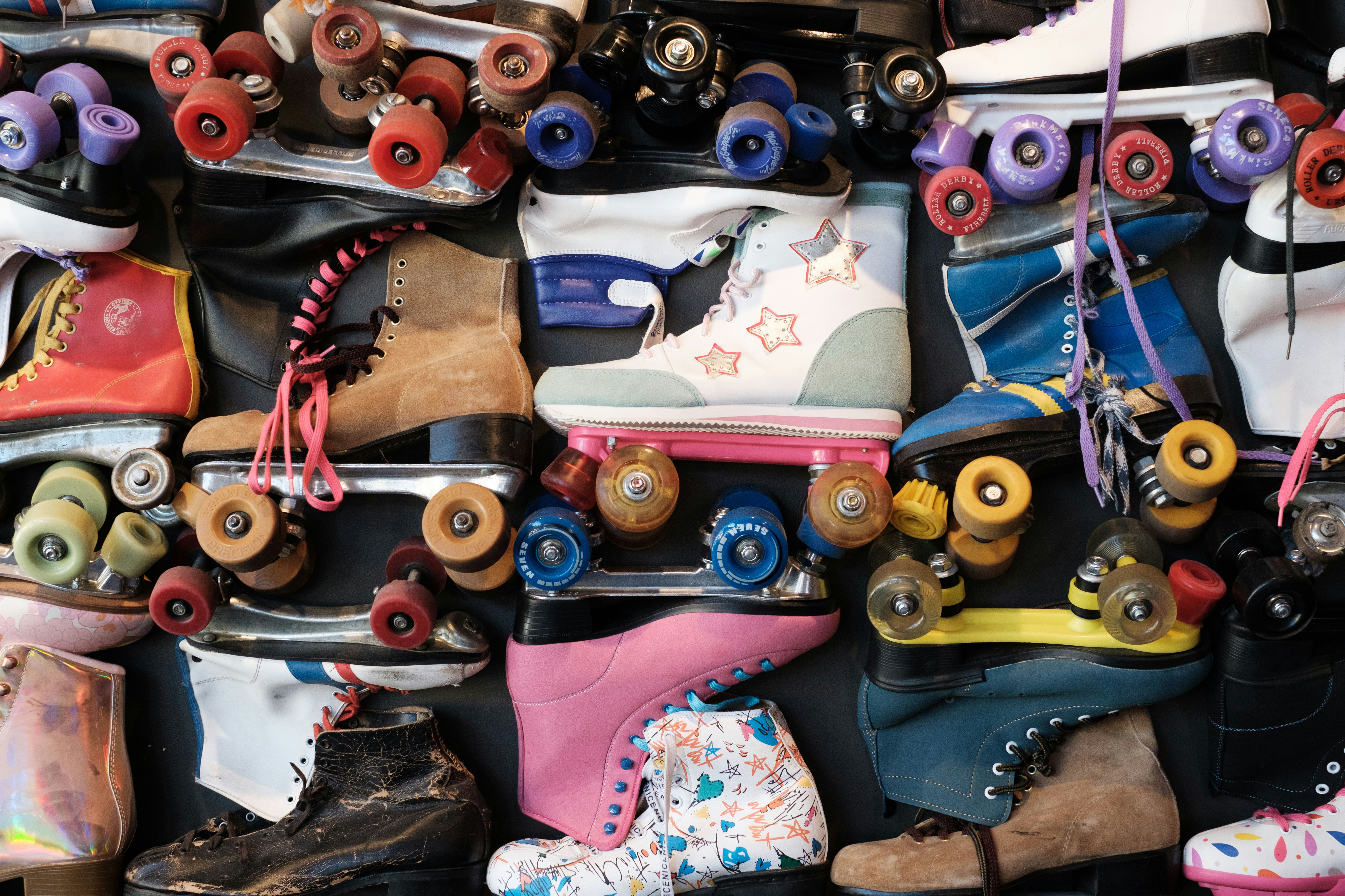 A bunch of roller skates that are stacked on top of each other photo ...