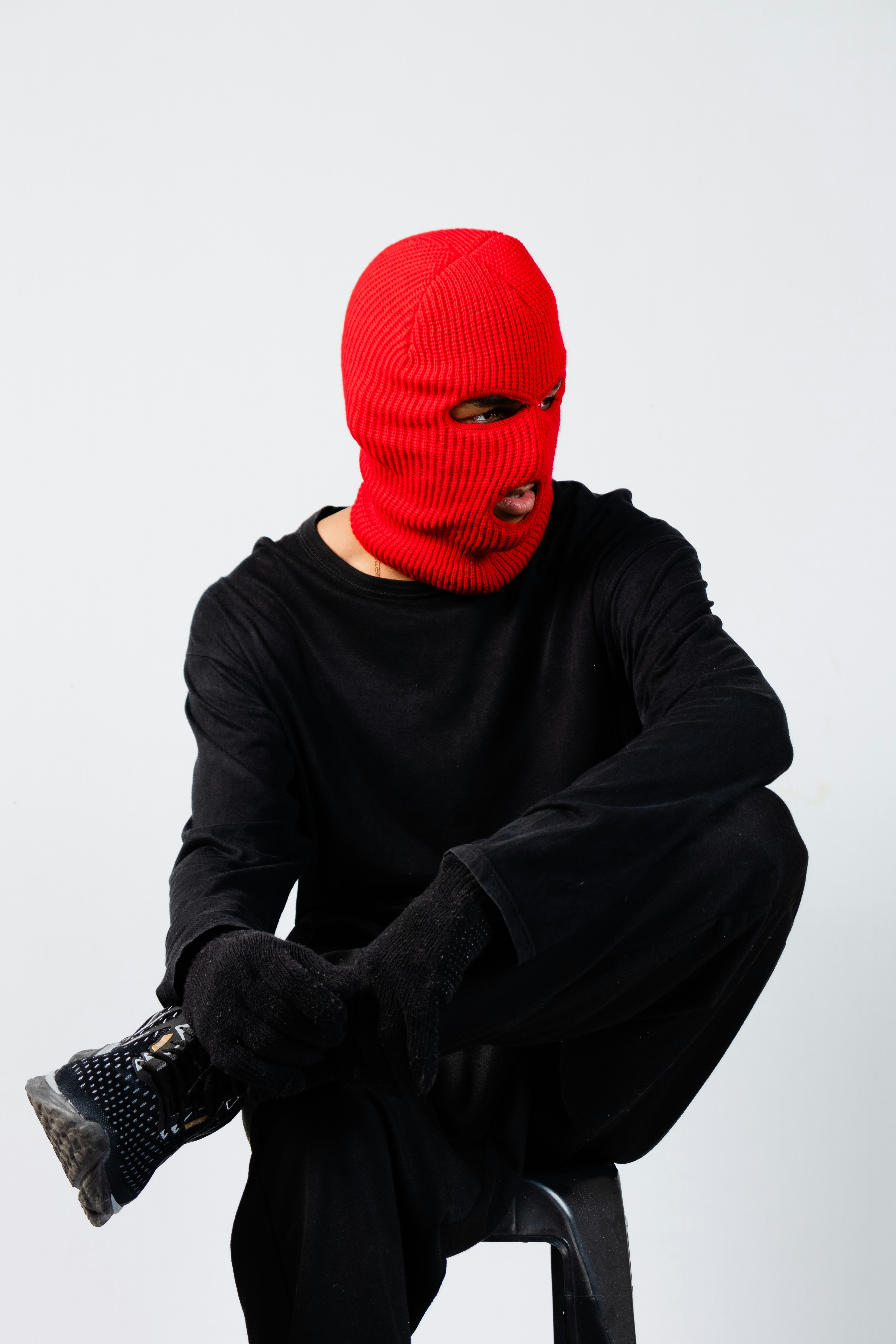 A man in a red mask sitting on a stool photo – Free Portrait Image on ...