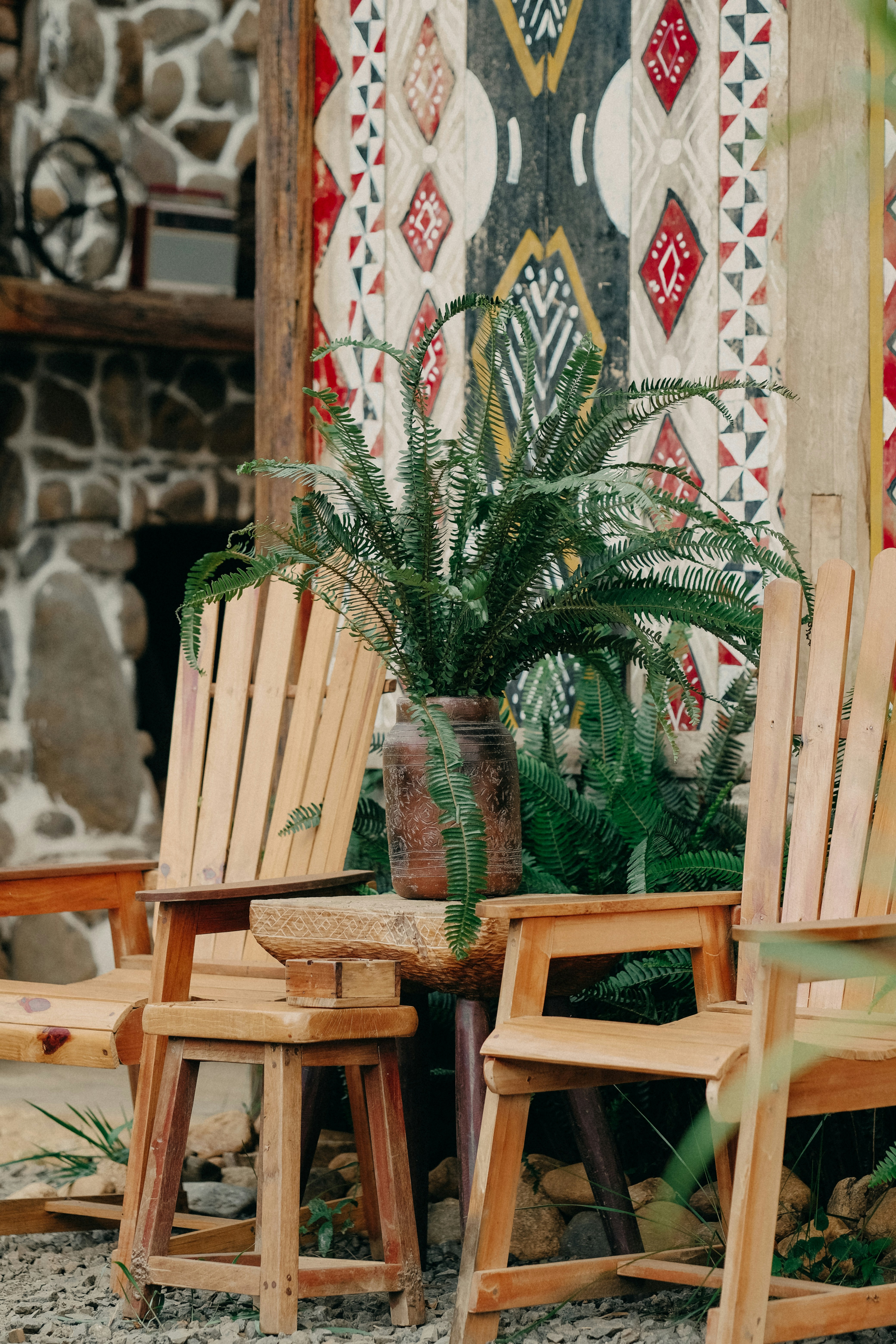 Fern Centerpiece Between Adirondack Chairs Under a Diamond-Tiled Backdrop