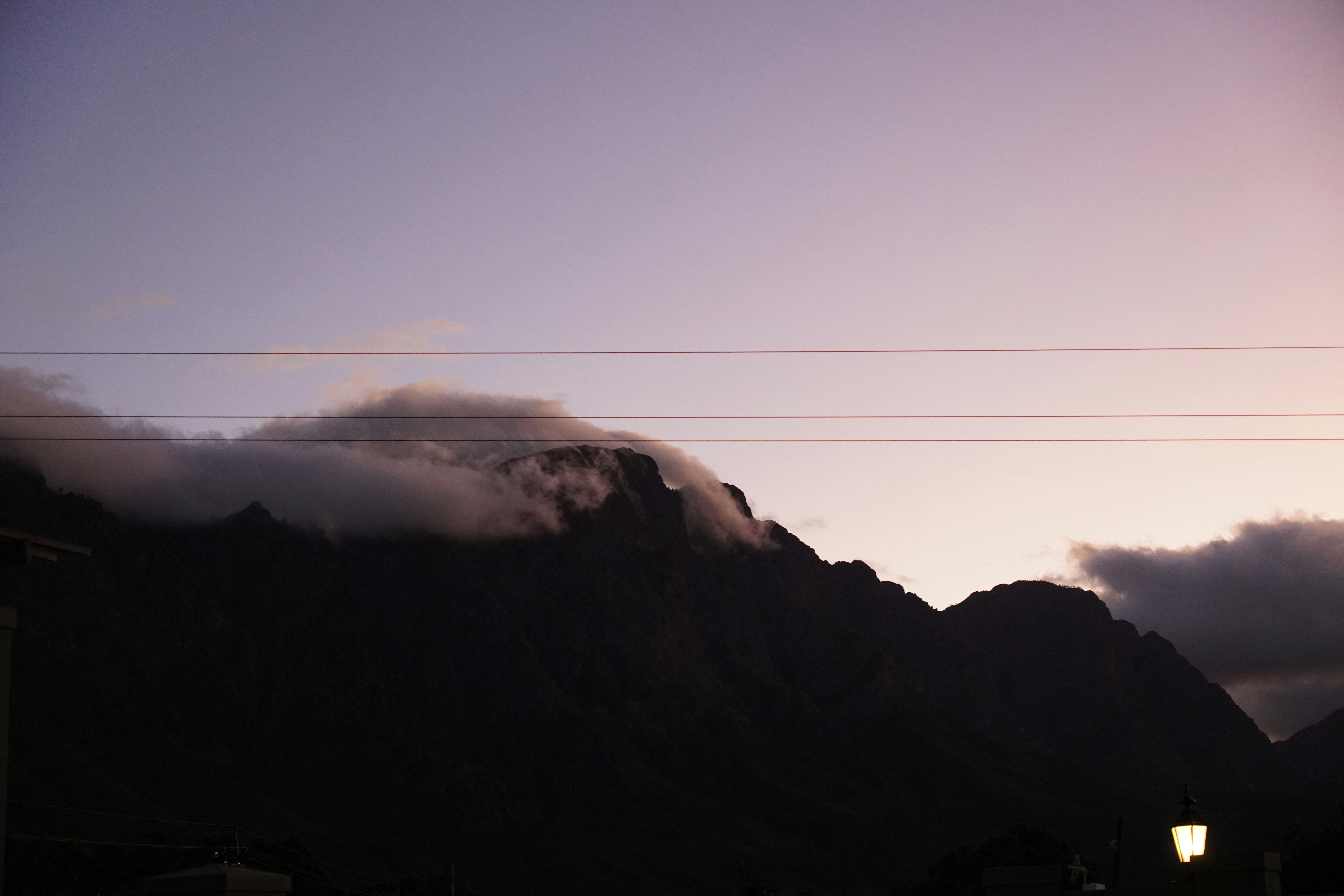 Dawn Crest: Clouds Glide Over a Quiet Mountain Ridge