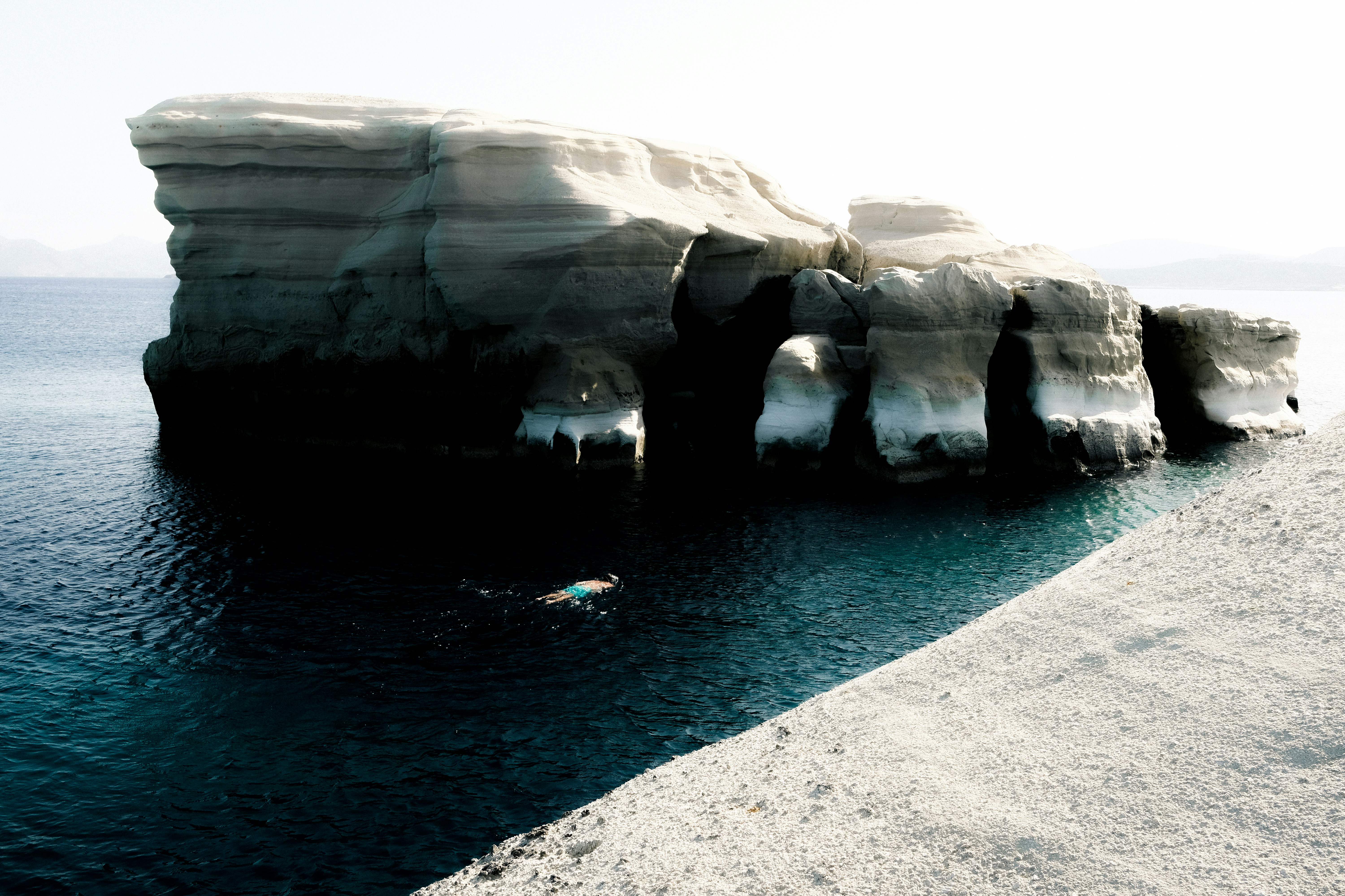 Sea-Arch Sentinel: White Limestone Emerges from Deep Blue
