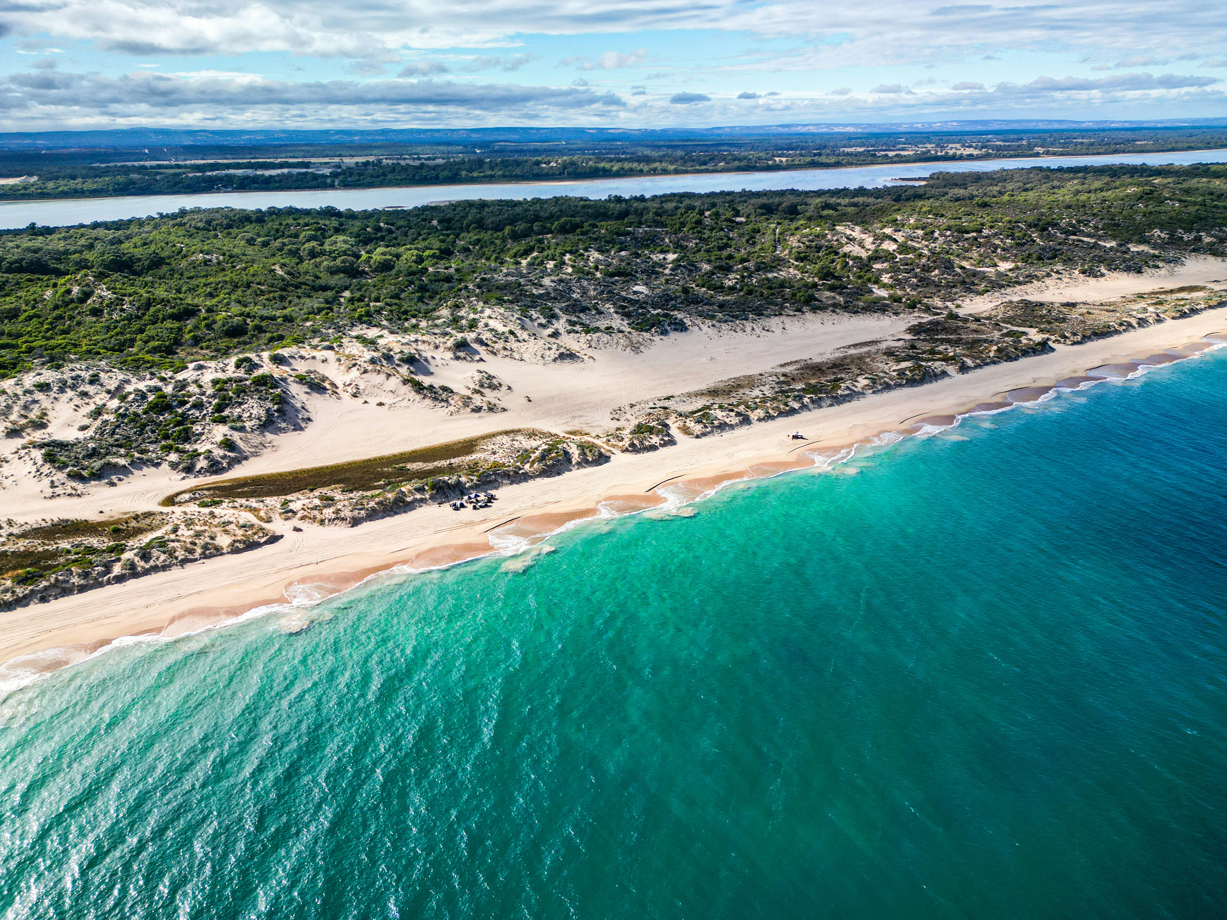 An aerial view of a sandy beach and ocean photo – Free Preston Image on ...