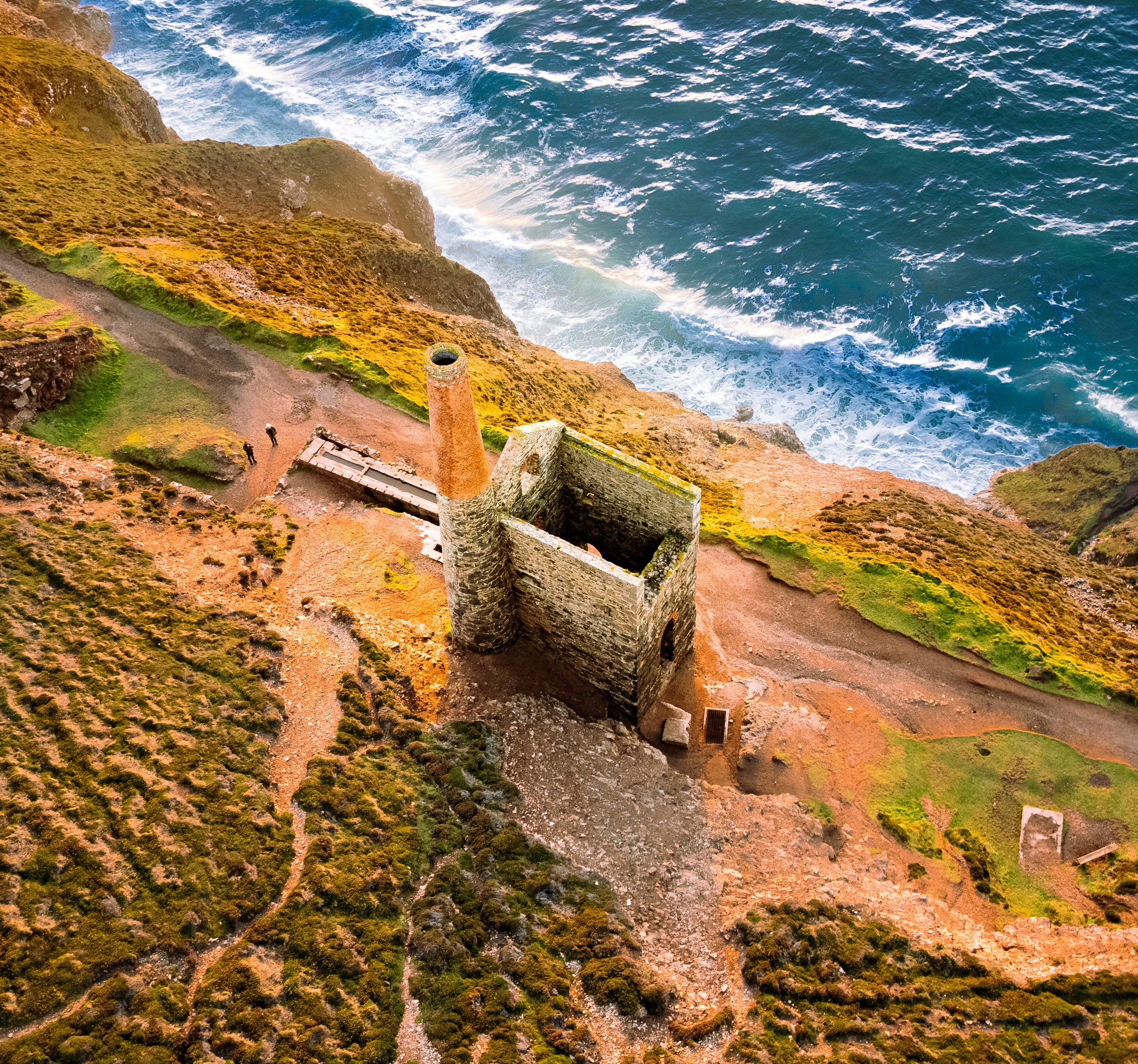 An aerial view of a building near the ocean photo – Free Wheal coates ...