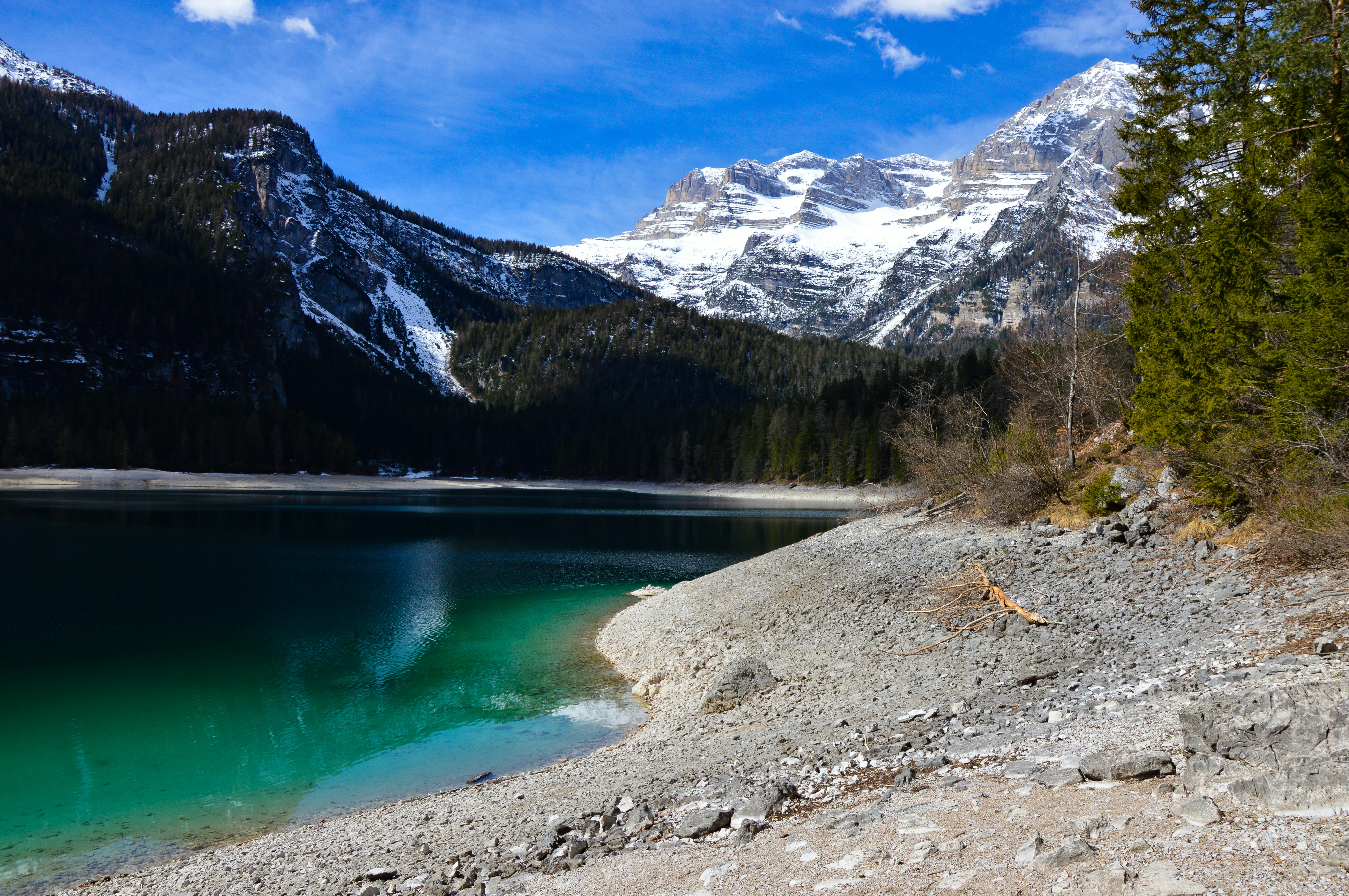 A mountain lake surrounded by snow covered mountains photo – Free Lago ...