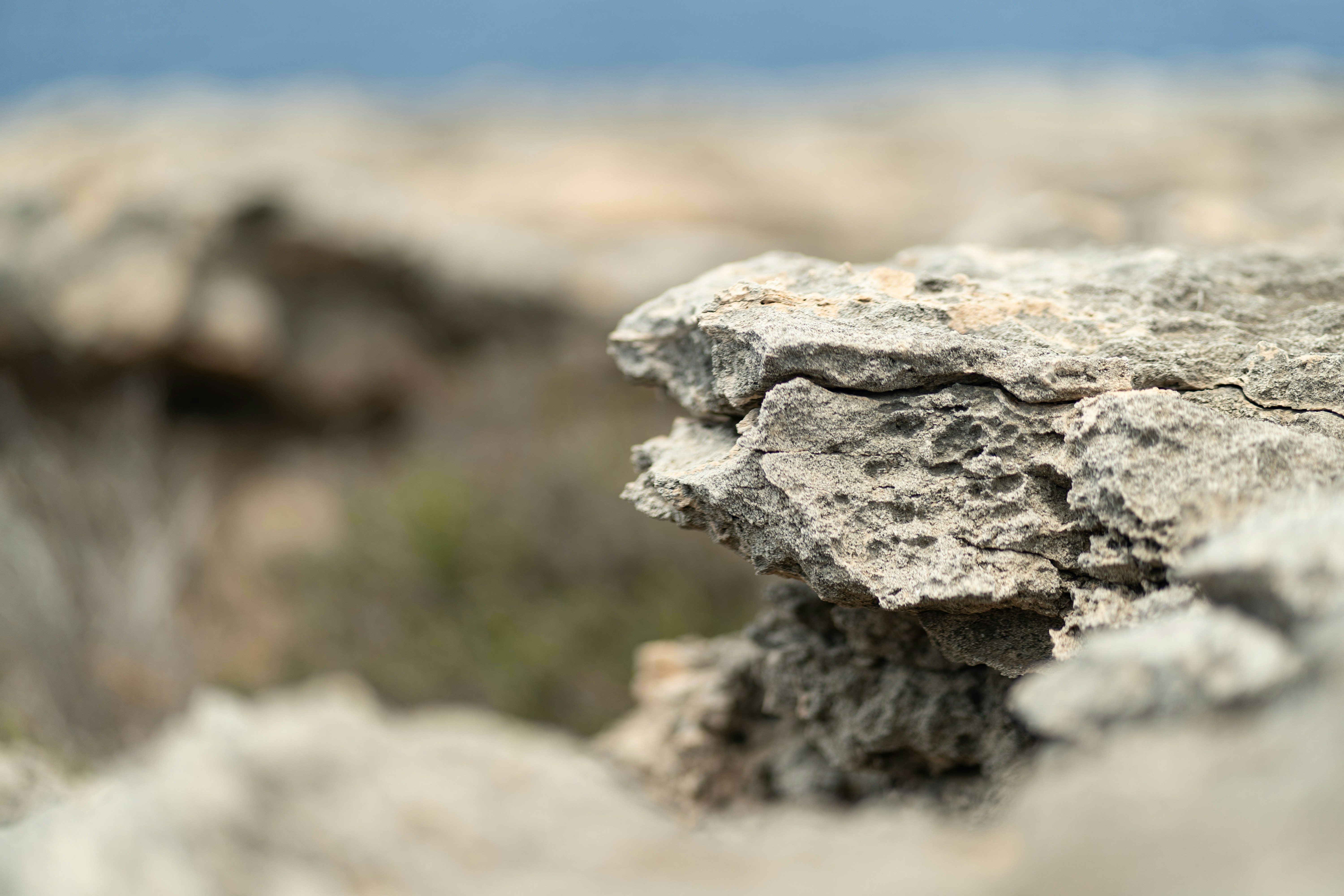 A close up of a rock with a blue sky in the background photo – Free ...